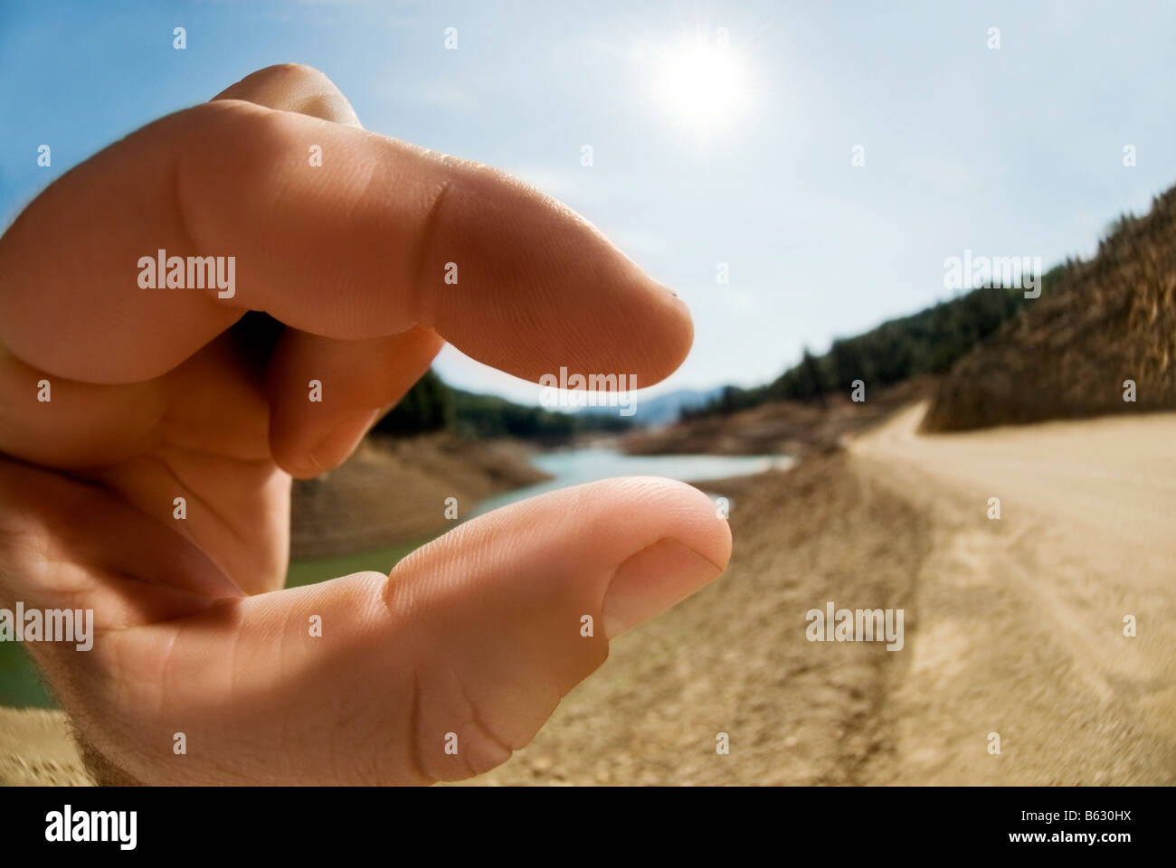 Close-up of a person's hand pretending to hold a lake, Shasta Lake ...
