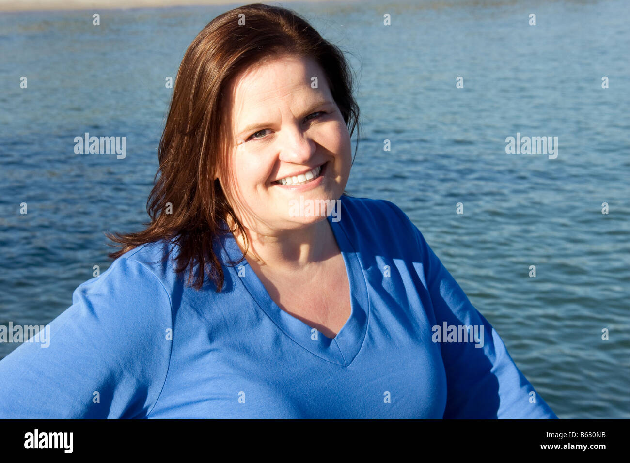 Beautiful plus sized model posing by the water Stock Photo - Alamy