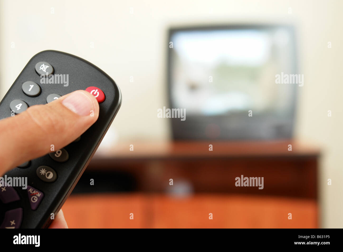 Television screen with tv remote control in foreground Stock Photo - Alamy
