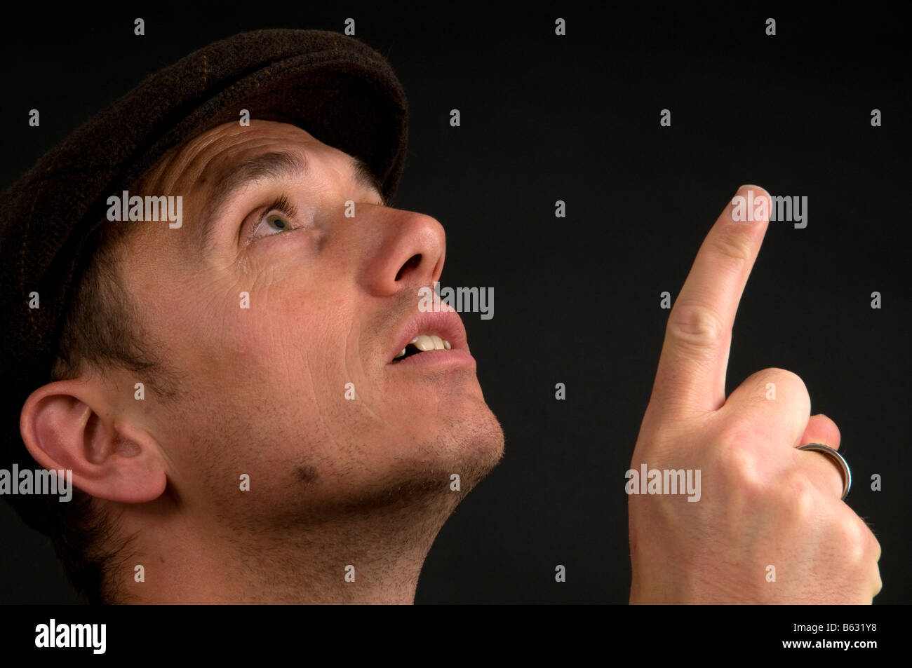 Young man pointing up Stock Photo - Alamy