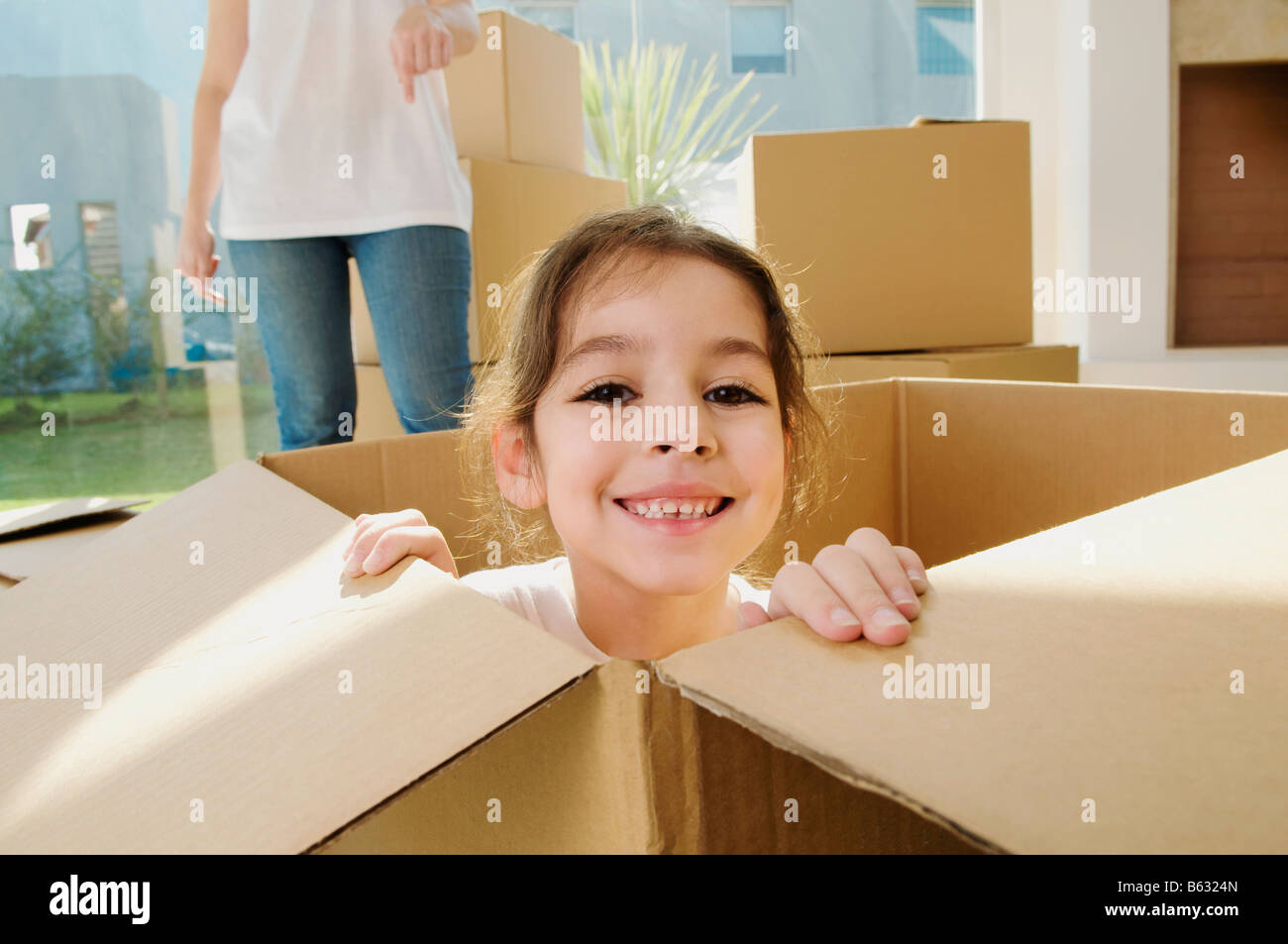 Portrait of a girl smiling in a cardboard box Stock Photo - Alamy