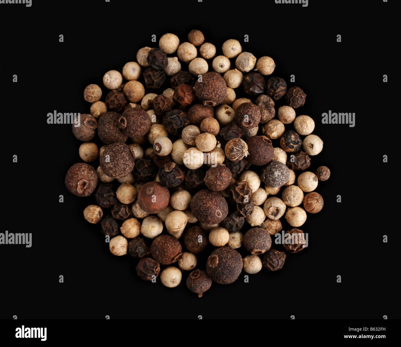 Dry spice pepper pea detail view on black Stock Photo - Alamy