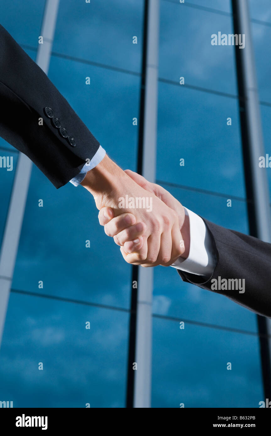 Two businessmen shaking hands Stock Photo - Alamy