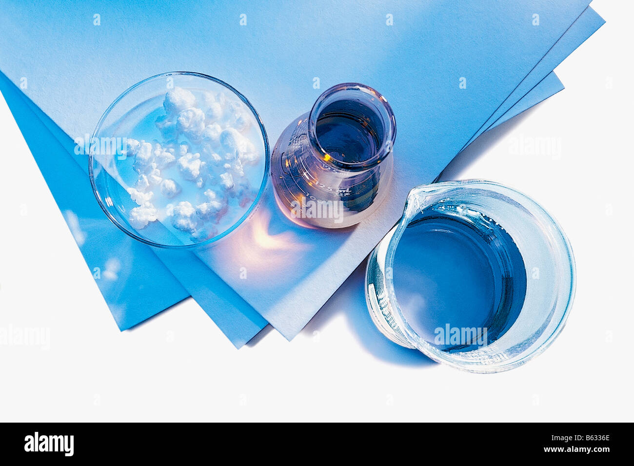 High angle view of a pitcher of water and a bowl of cream with sheets ...