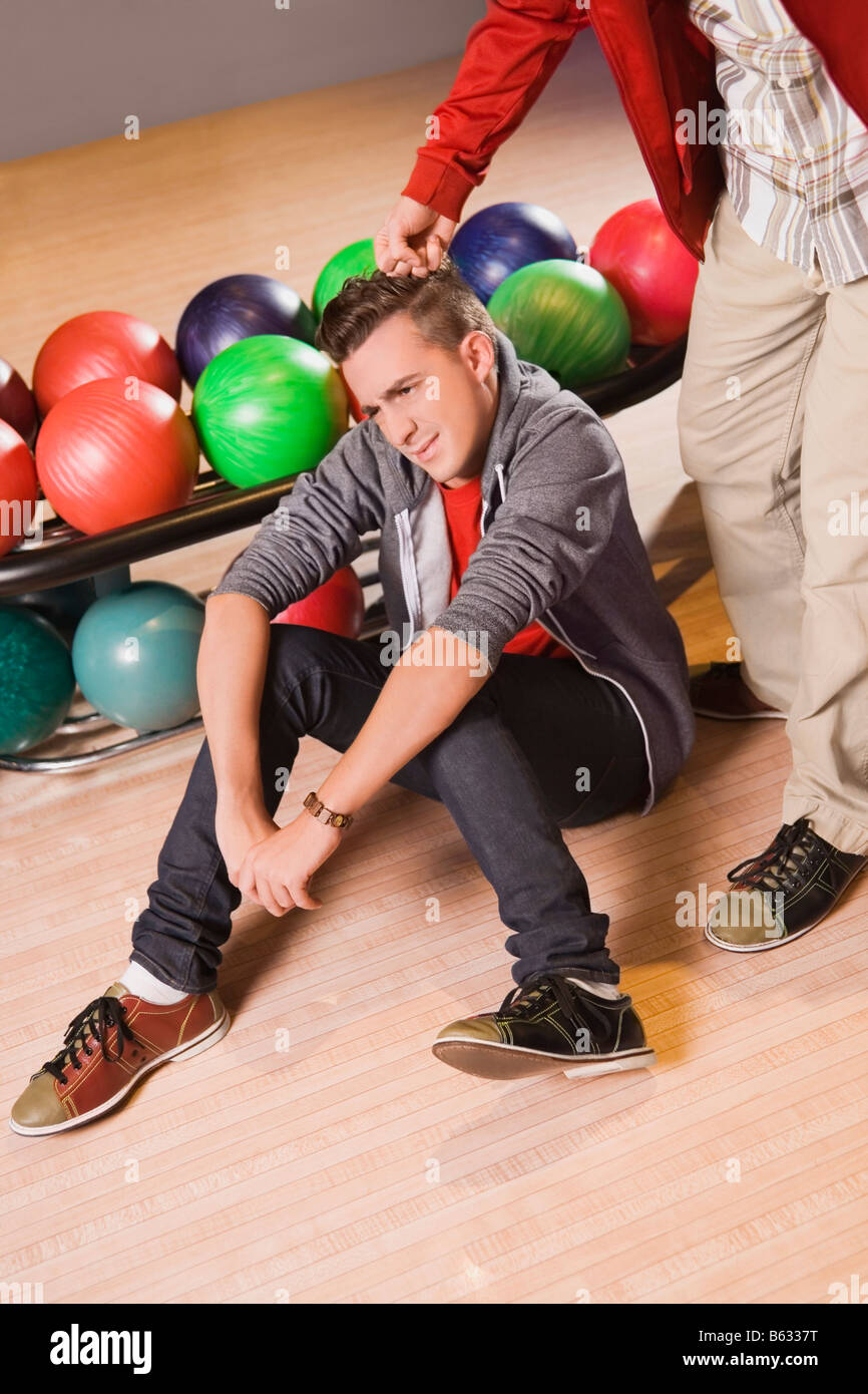 Low section view of a man punching on a young man's head Stock Photo ...