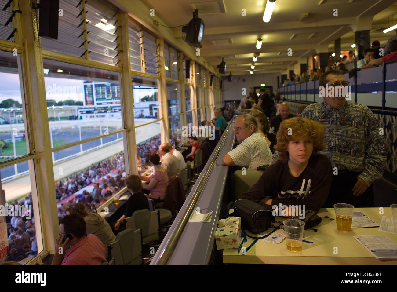 A restaurant full of people at a greyhound race track Stock Photo - Alamy