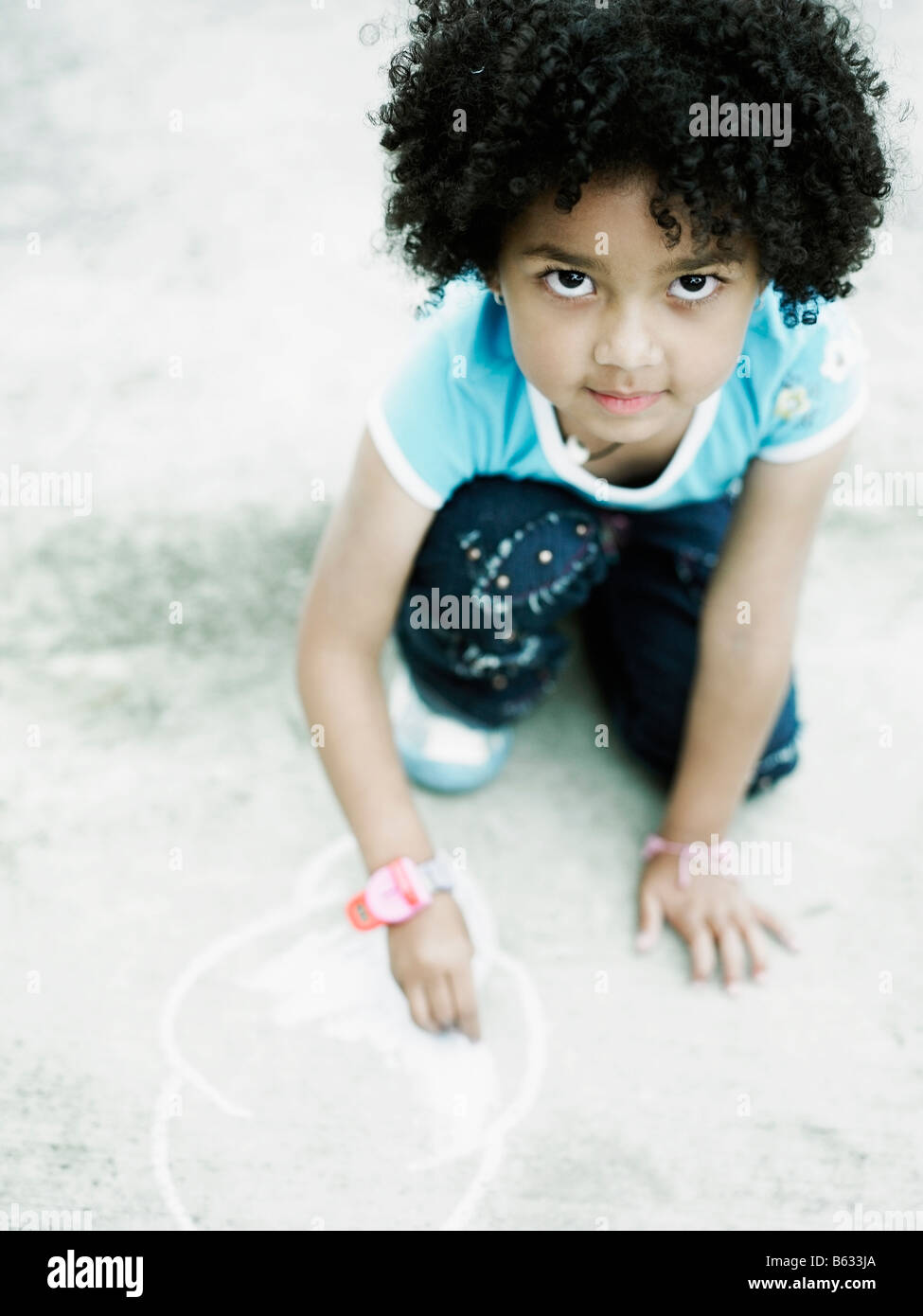 Portrait of a girl drawing with chalk on the floor Stock Photo - Alamy