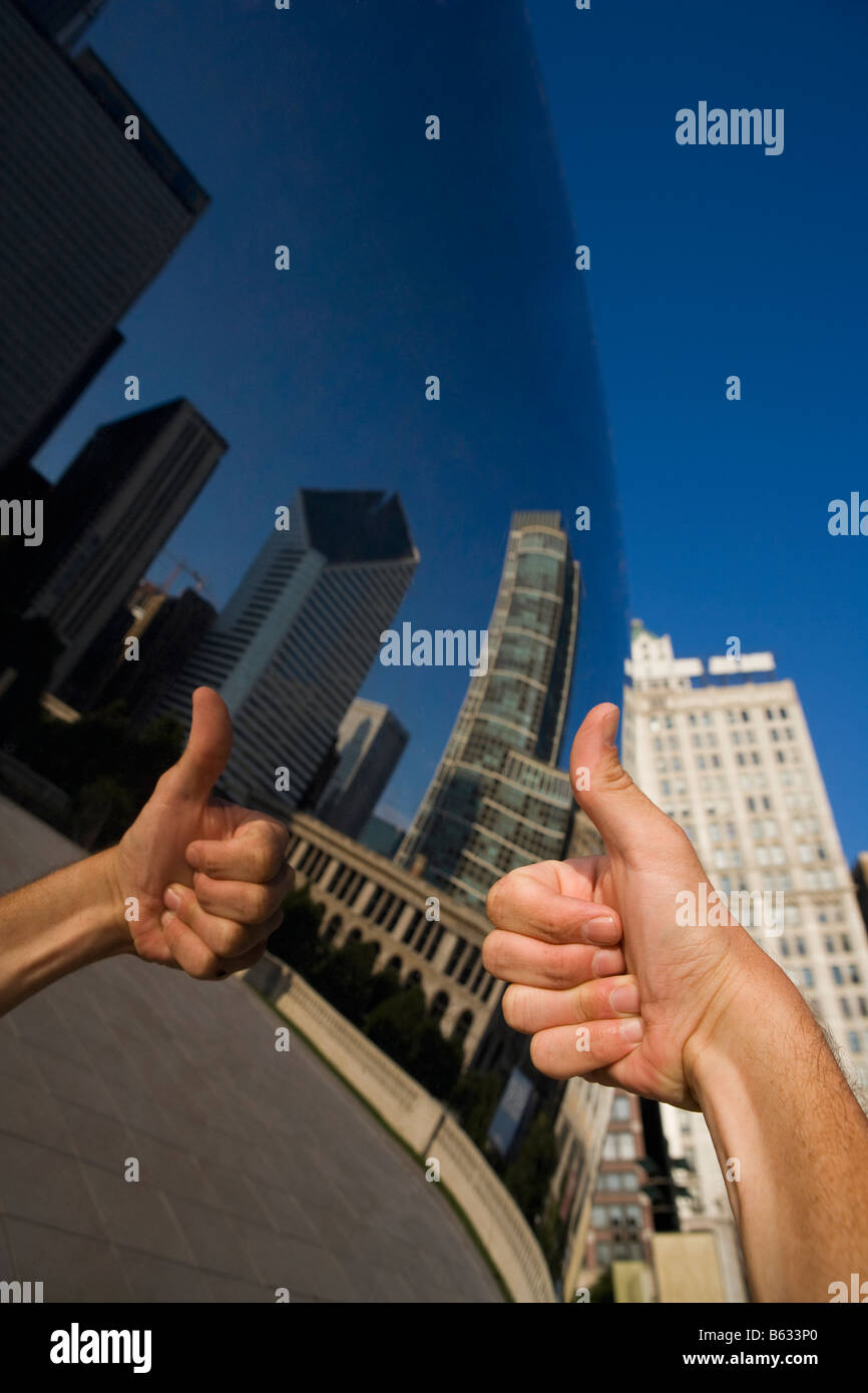 Reflection of thumbs up sign on a sculpture, Cloud Gate, Millennium ...