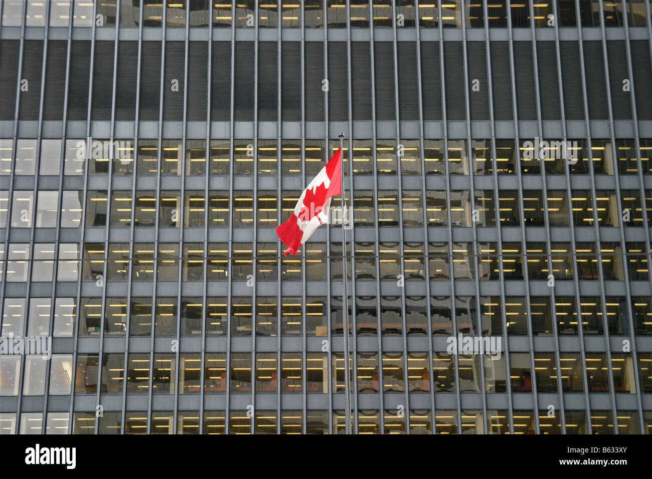 canadian flag waving against dark skyscraper windows Stock Photo - Alamy
