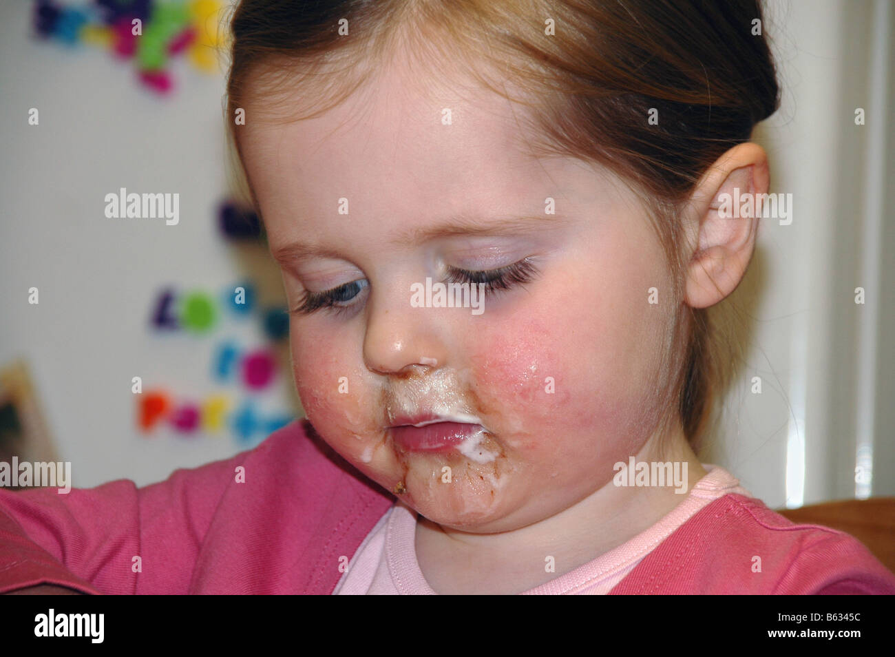 A close up of a girls messy face while eating ice cream Stock Photo - Alamy