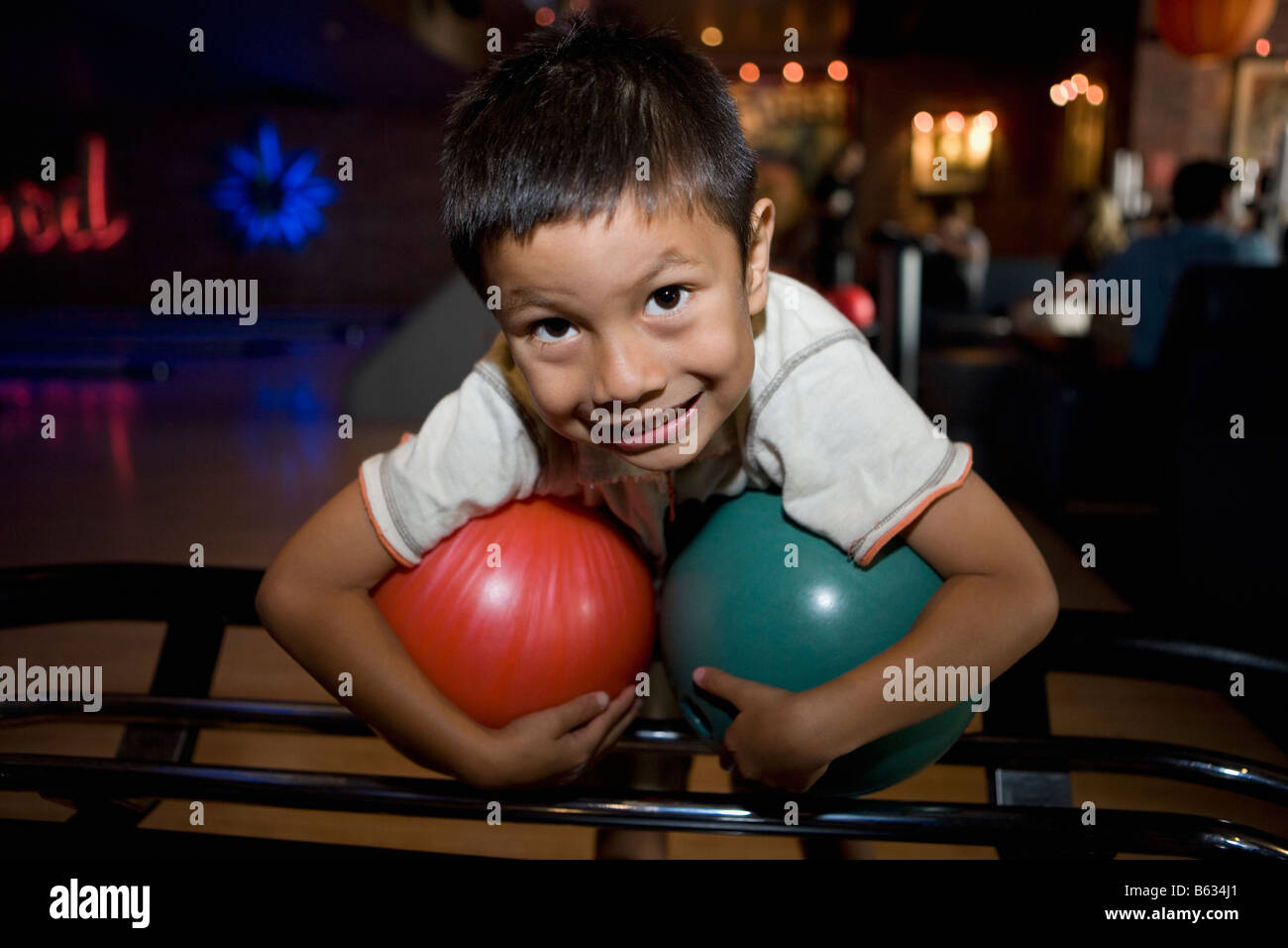 Portrait of a boy holding a bowling ball Stock Photo - Alamy