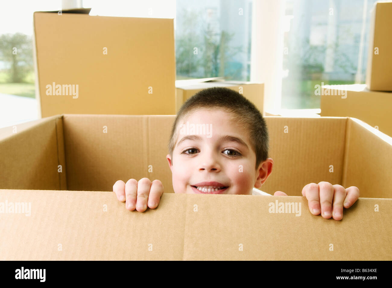 Portrait of a boy smiling in a cardboard box Stock Photo - Alamy