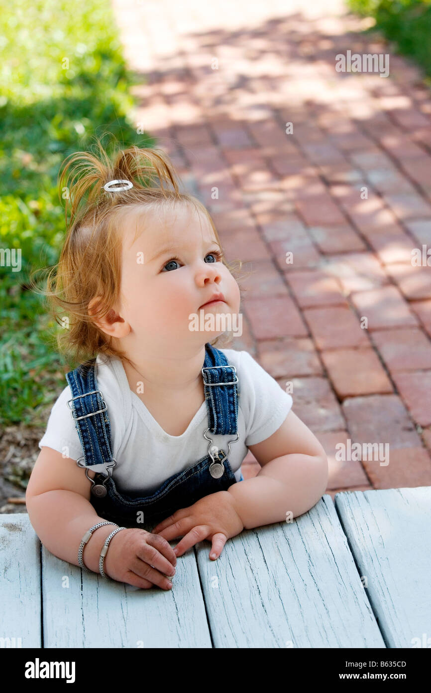 Baby girl looking up Stock Photo - Alamy