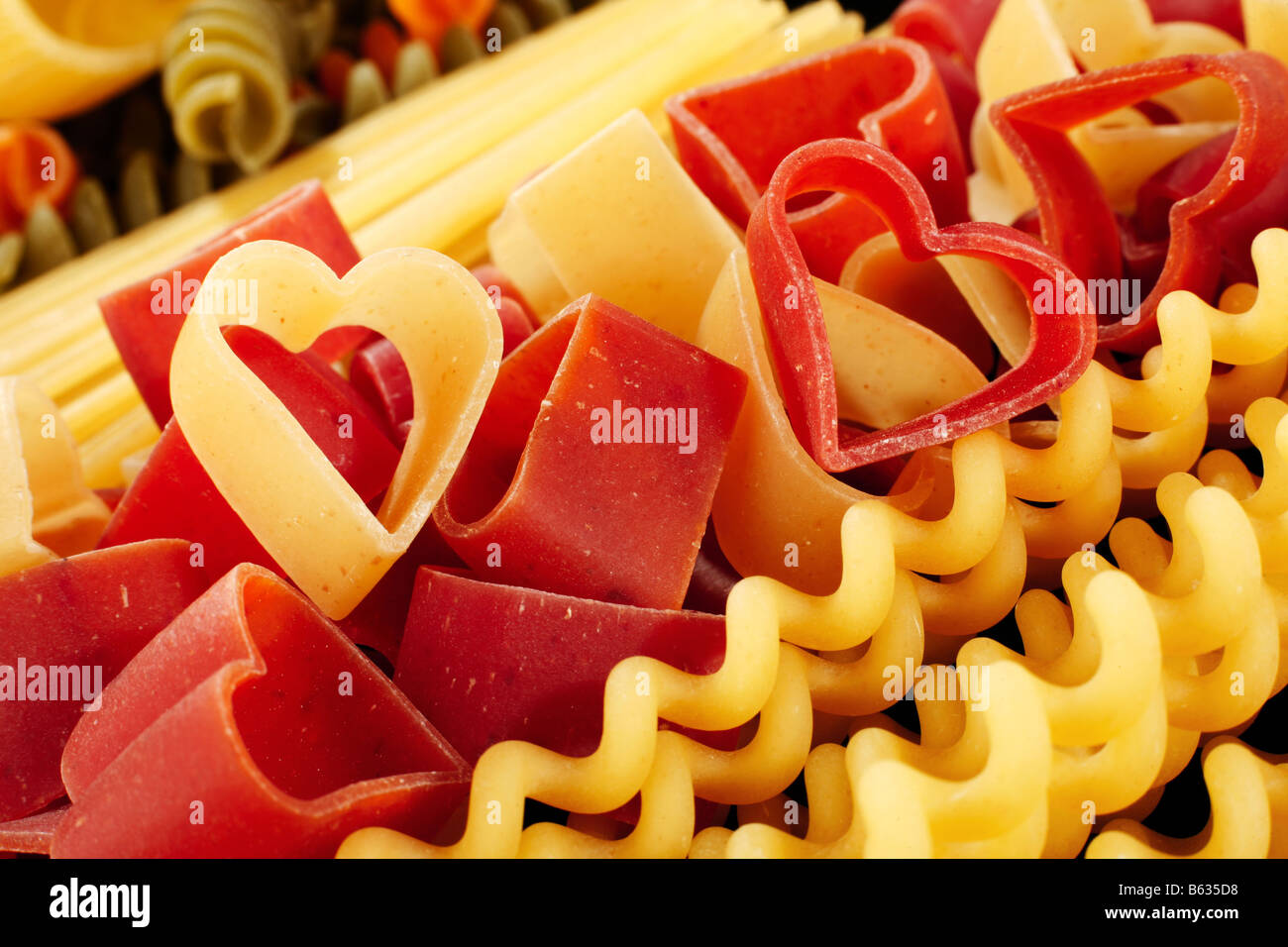 Raw color pasta mix closeup background Stock Photo - Alamy