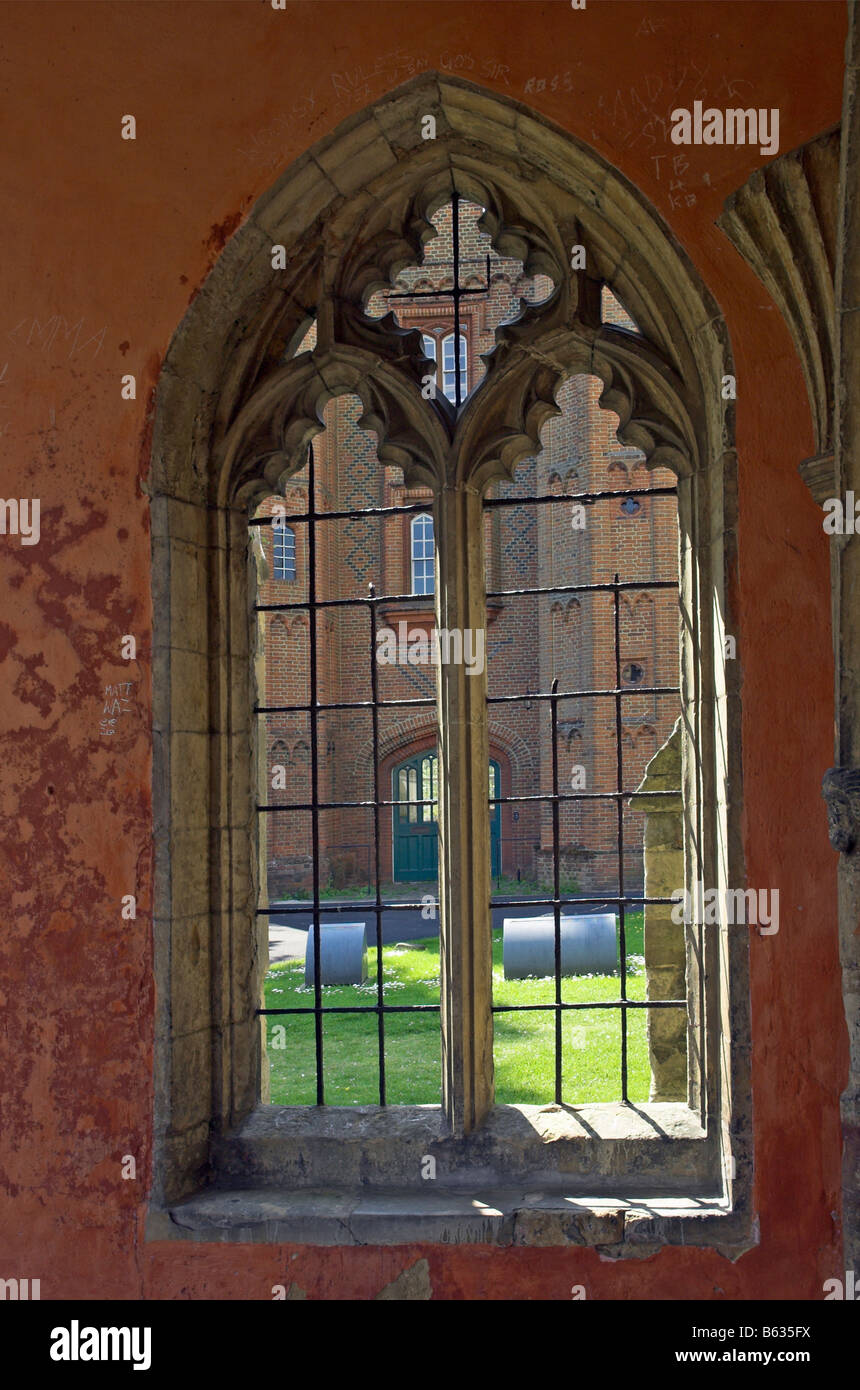 An arched window in Hadleigh church in Suffolk with the deanery tower ...
