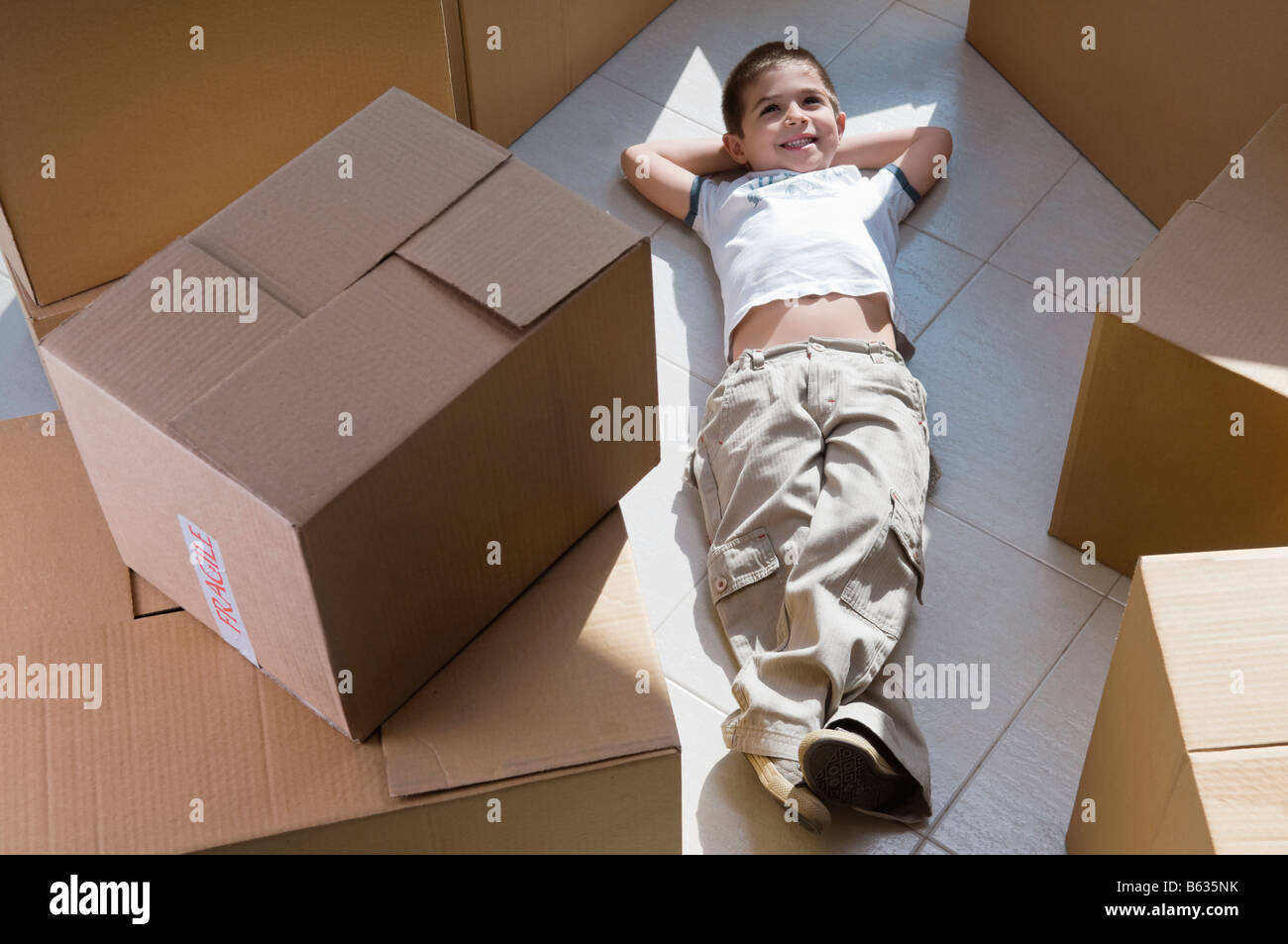 High angle view of a boy lying on the floor and smiling Stock Photo - Alamy