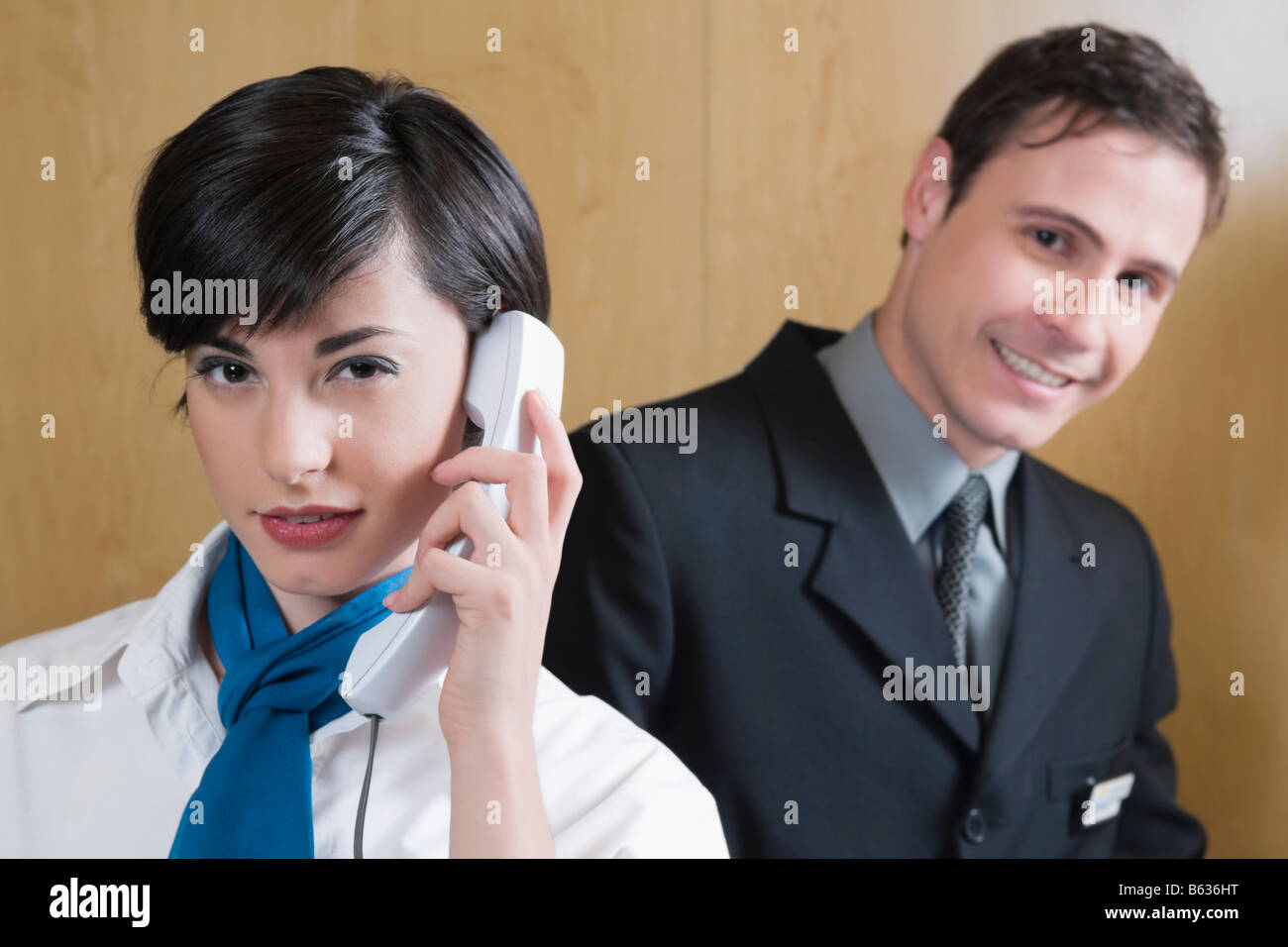 Hotel receptionist talking on telephone hi-res stock photography and ...