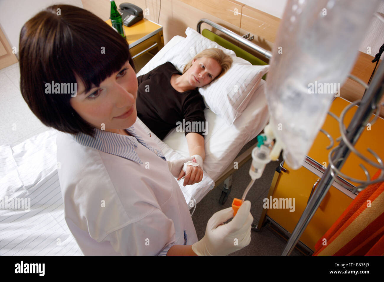 Nurse installs an infusion for a patient in a hospital Stock Photo - Alamy