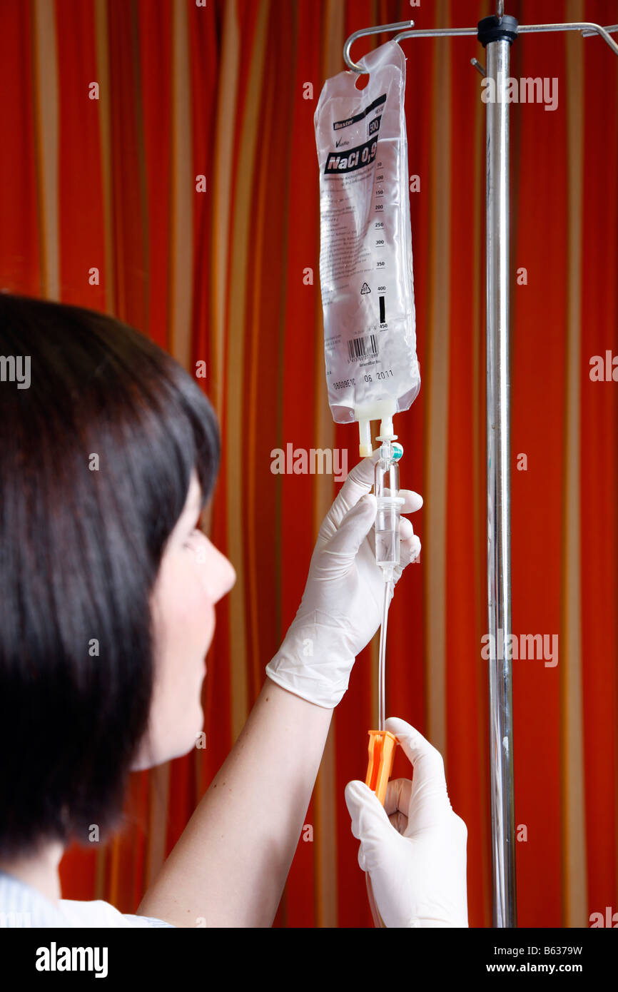 Nurse installs an infusion for a patient in a hospital Stock Photo - Alamy