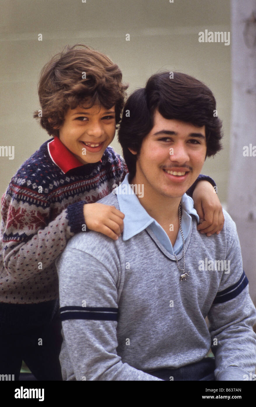Young Hispanic man and his younger brother hug Stock Photo - Alamy