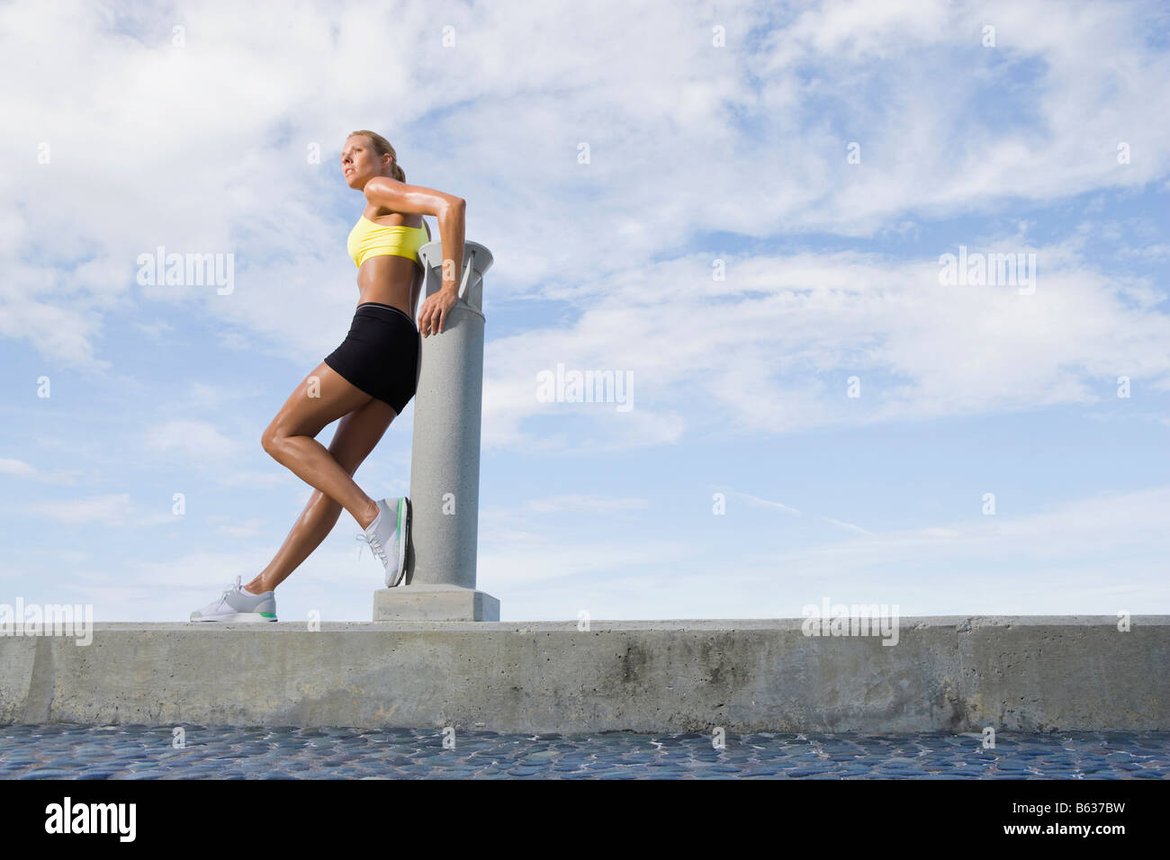 Woman standing by a column woman standing by a column hi-res stock ...