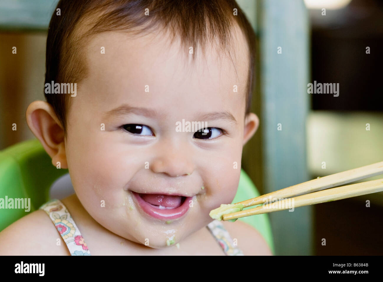 Girl child eating with chopsticks hi-res stock photography and images ...