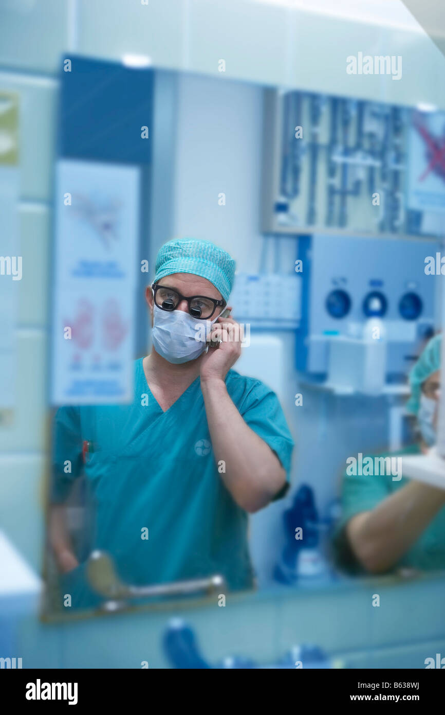 Reflection of Heart Surgeon wearing surgical glasses using cell phone ...