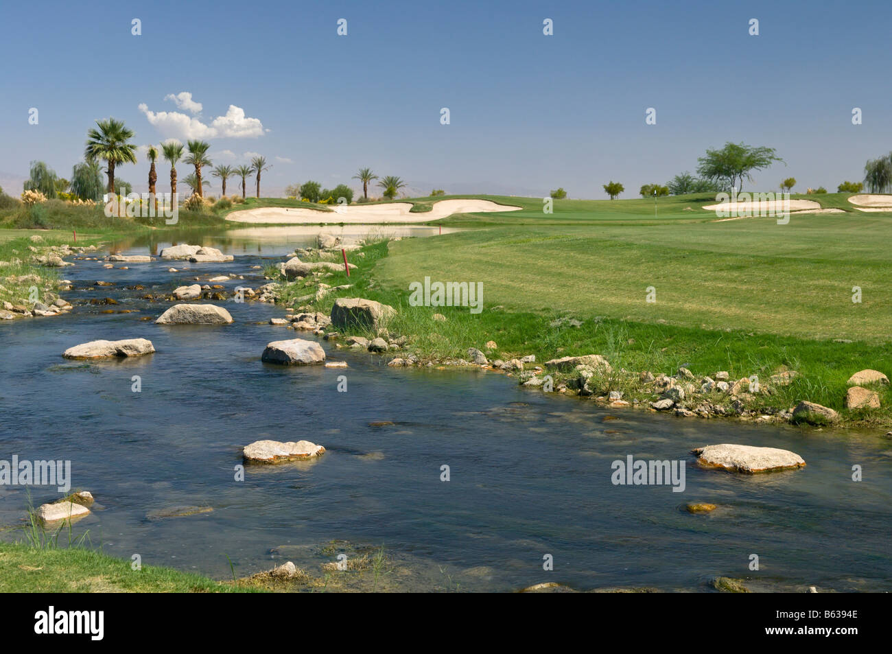 A stream flowing from the lake on the left side of the fairway at one ...