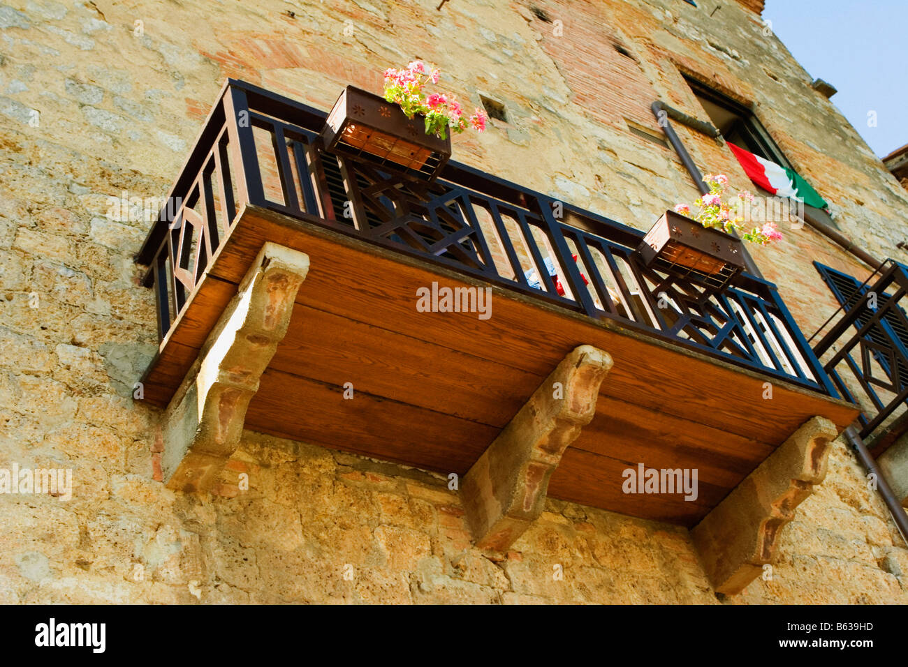 Low angle view of window boxes at a balcony, San Gimignano, Siena ...