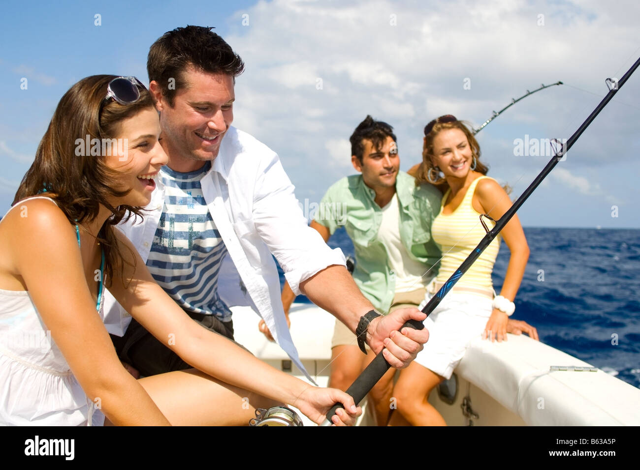 Two couples fishing in the sea Stock Photo - Alamy