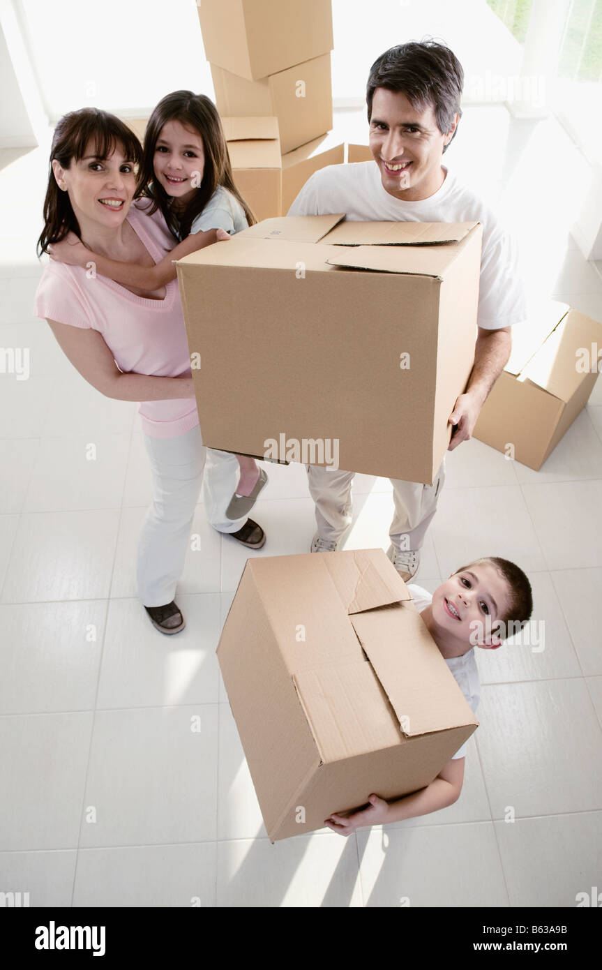 High angle view of a family carrying cardboard boxes Stock Photo - Alamy