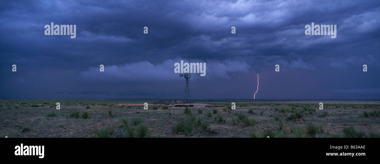 USA New Mexico Clovis Lightning strikes behind windmill during early ...