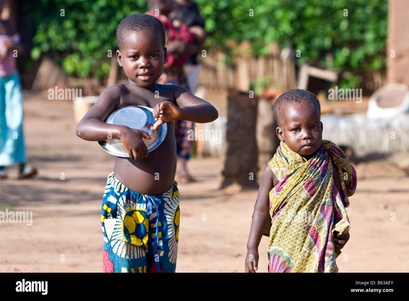 Two African children benefiting from a humanitarian aid project in ...
