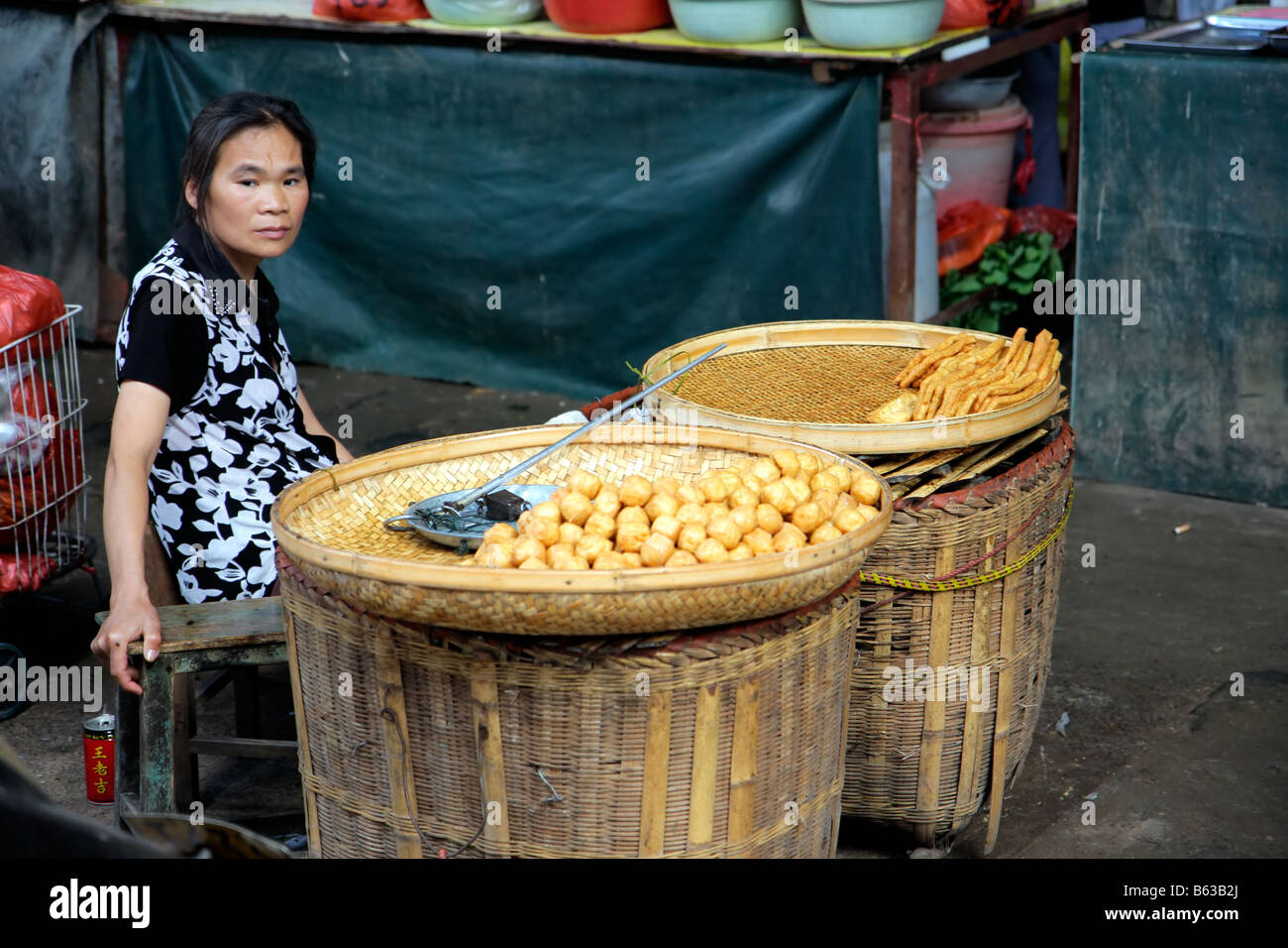 Chinese woman selling her fresh produce on a street market, Yangshuo ...