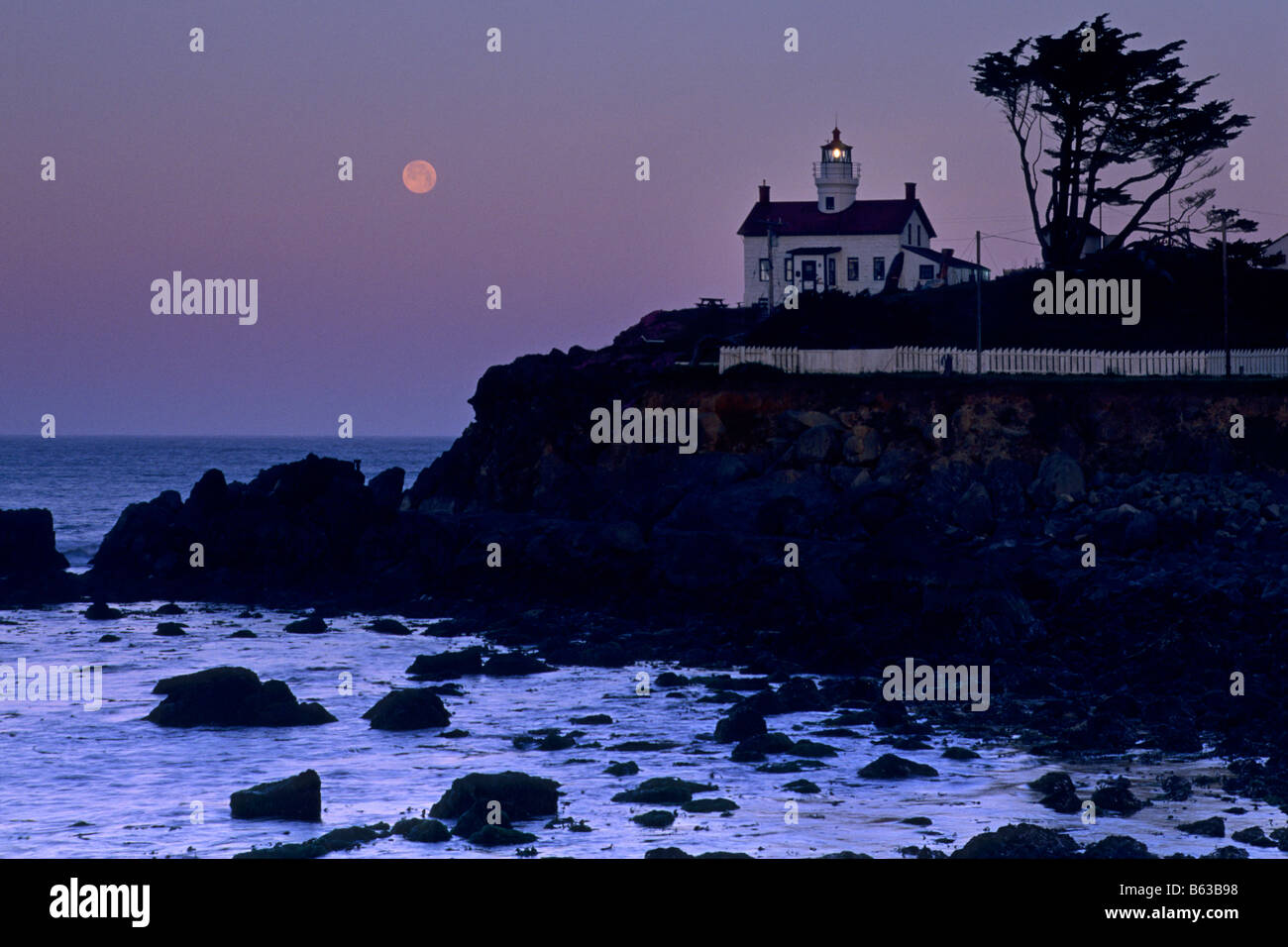 Full moon setting over Battery Point Lighthouse Crescent City Del Norte ...