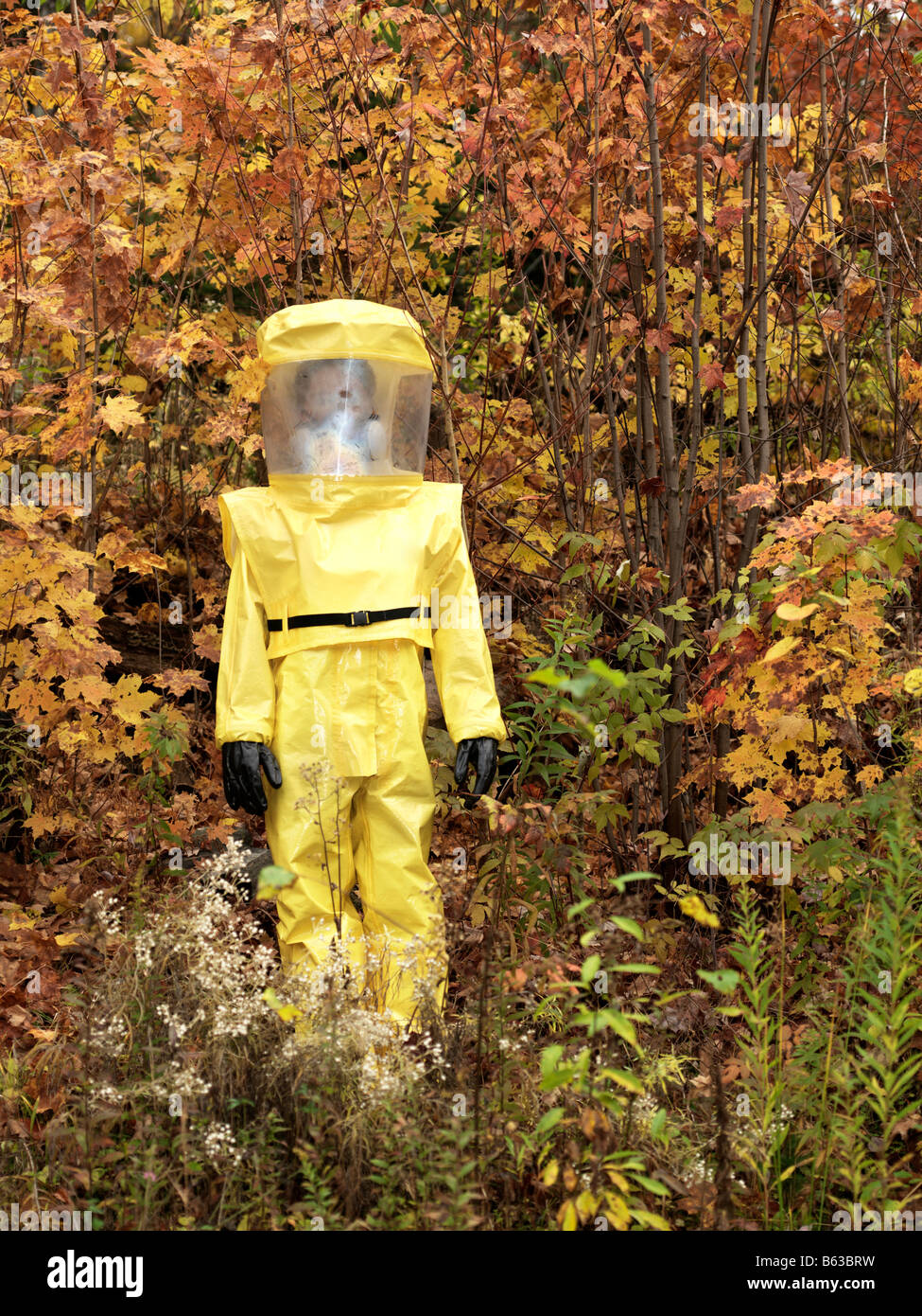 43 year old asian male in a hazmat suit and gas mask outdoors with the ...