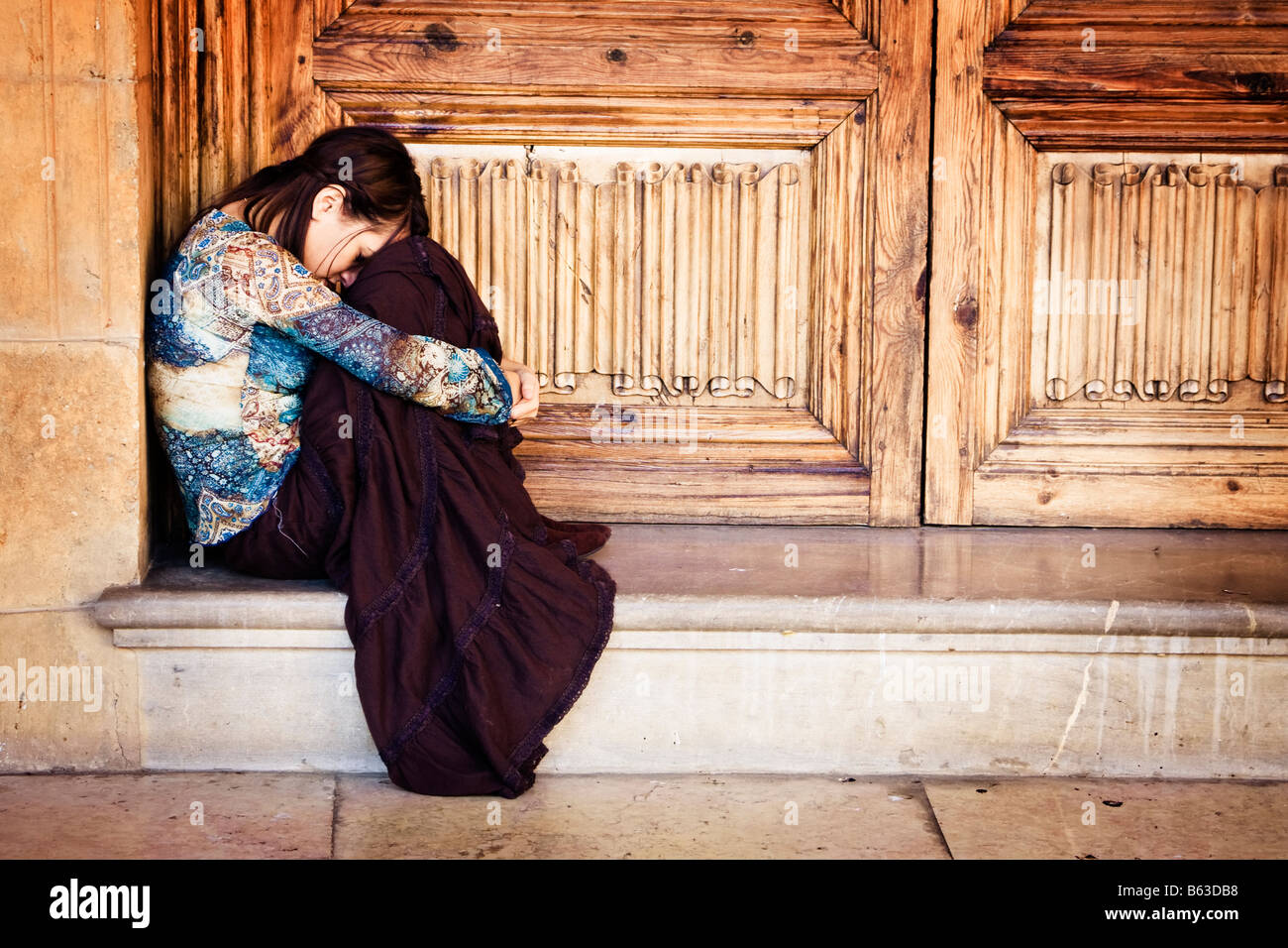Sad elegant woman sitting and crying Stock Photo - Alamy