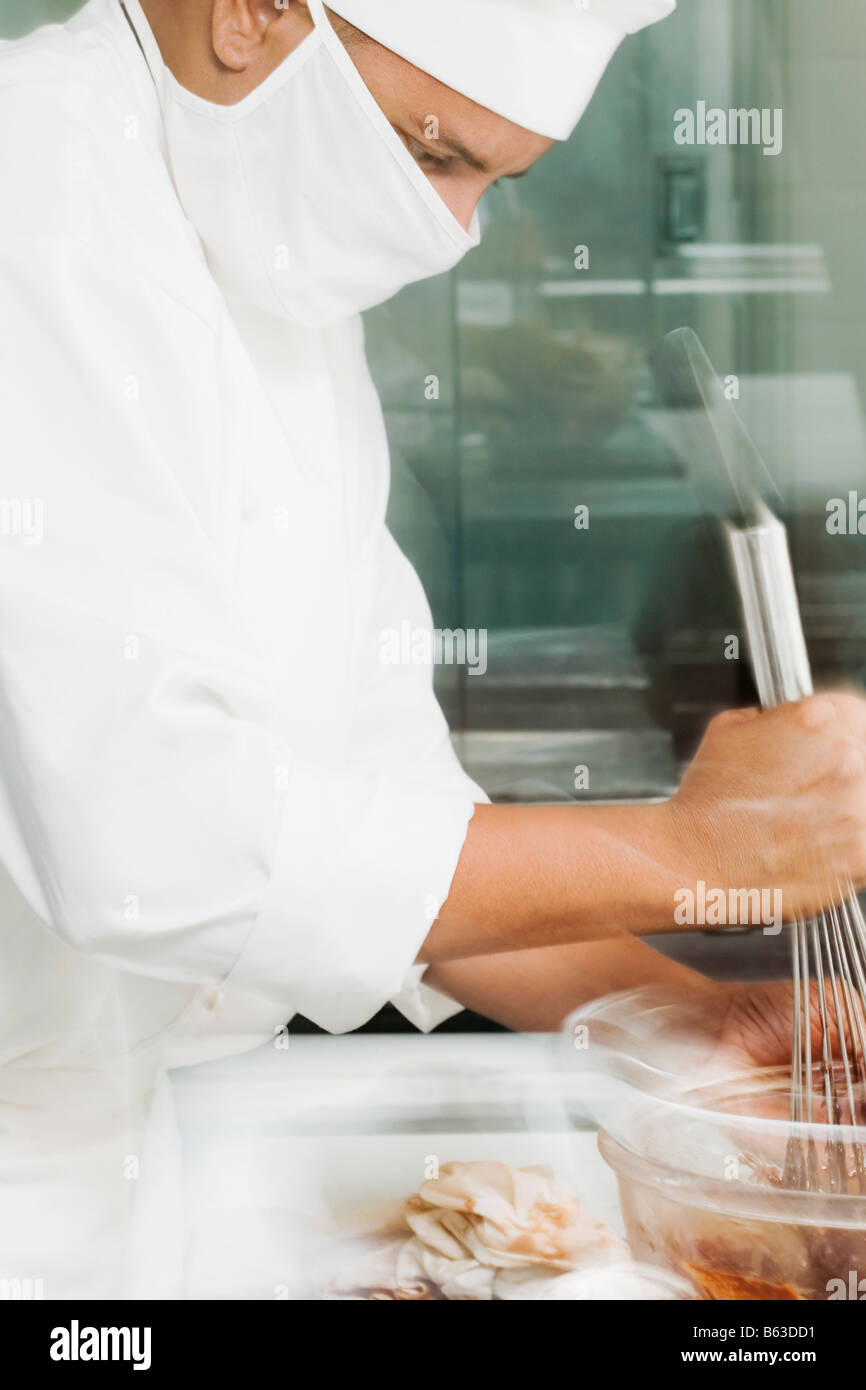 Side profile of a male chef preparing food Stock Photo - Alamy