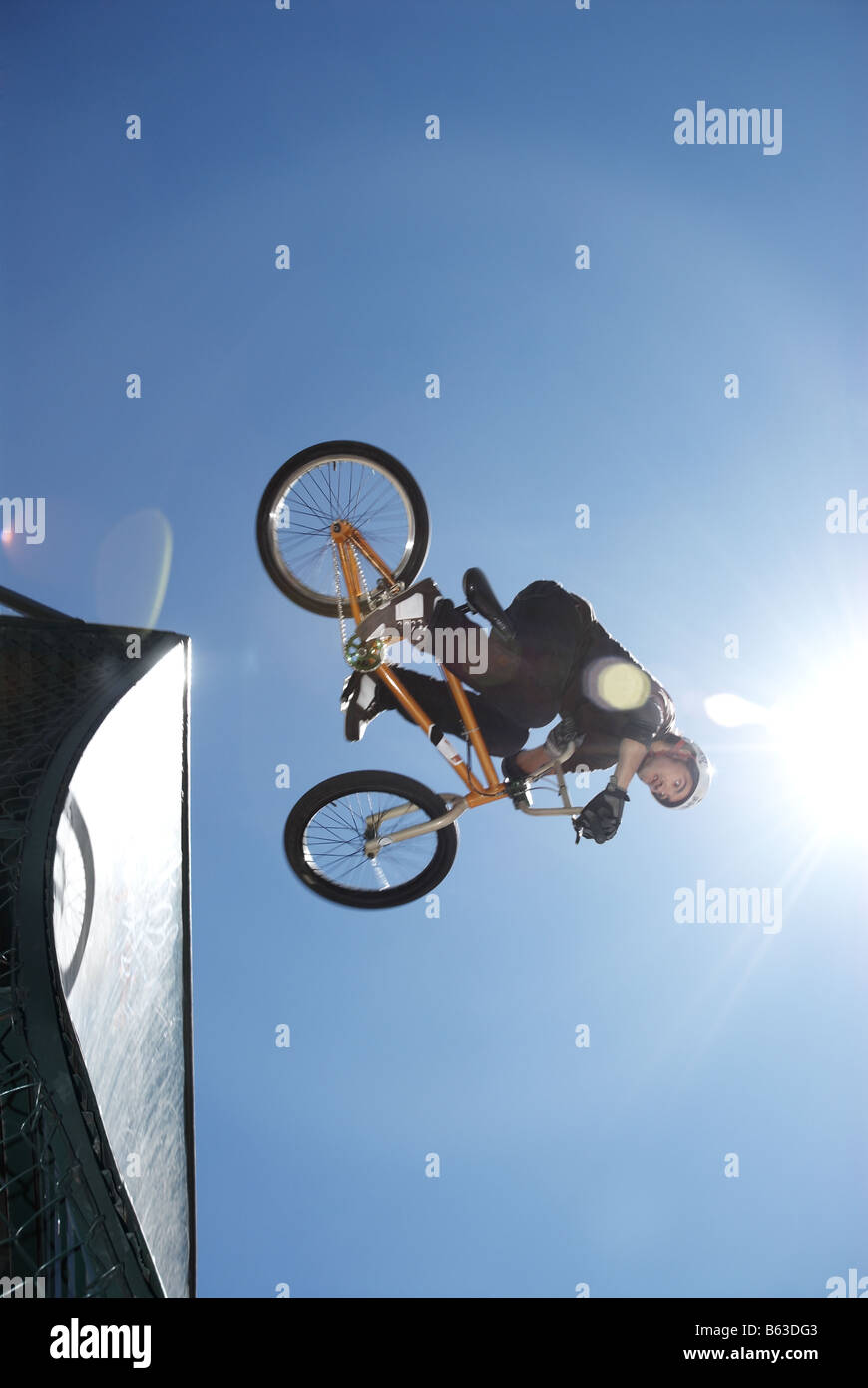 Low angle view of a BMX cyclist performing in mid-air Stock Photo - Alamy