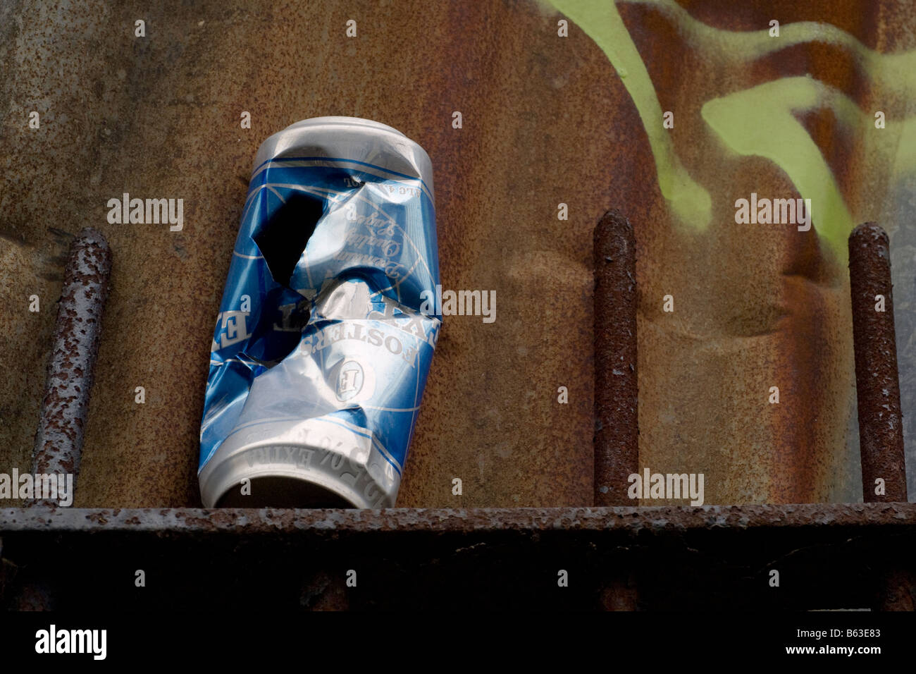 Empty beer can on rusting railing spike Stock Photo - Alamy