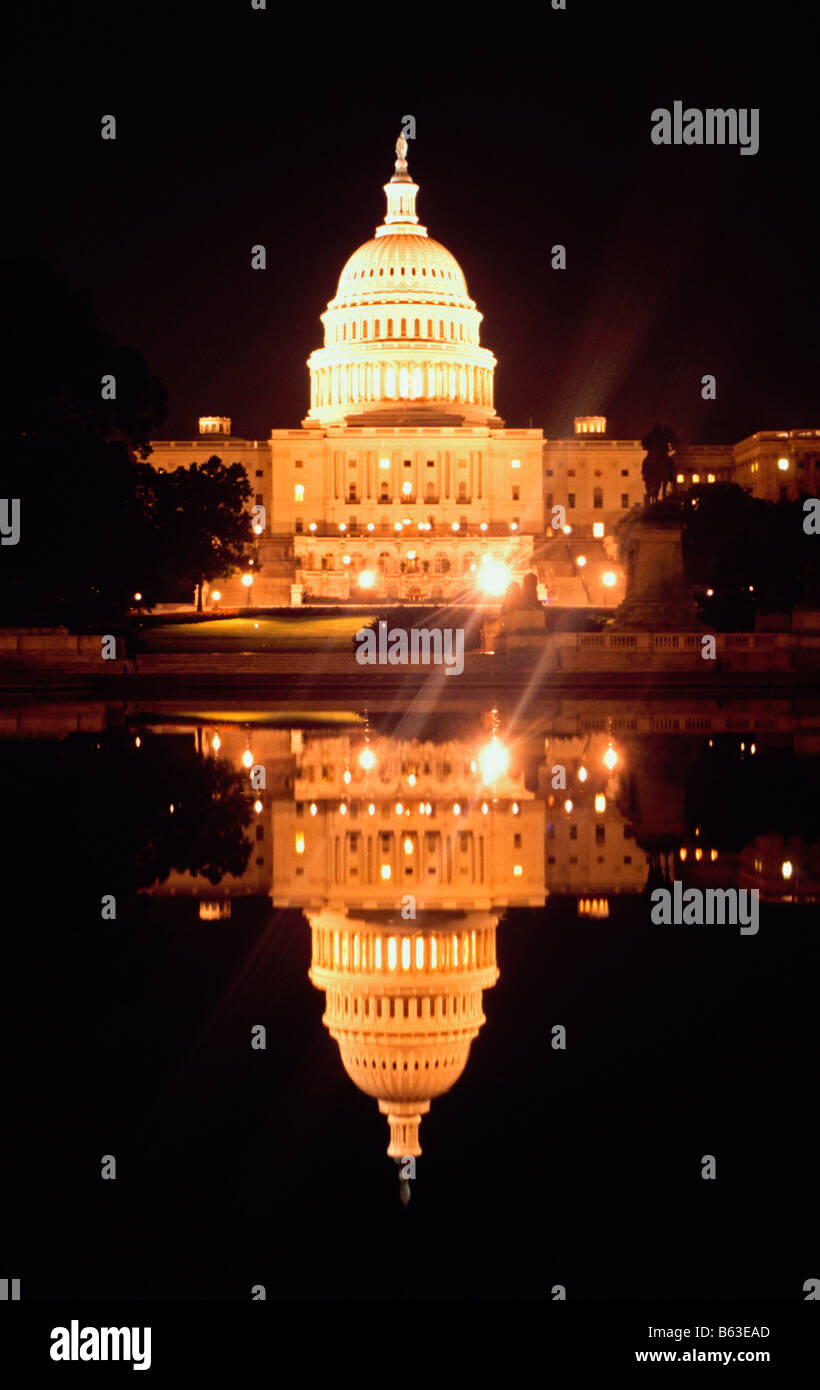 The US Capitol Building at night across the reflection pool, Washington ...