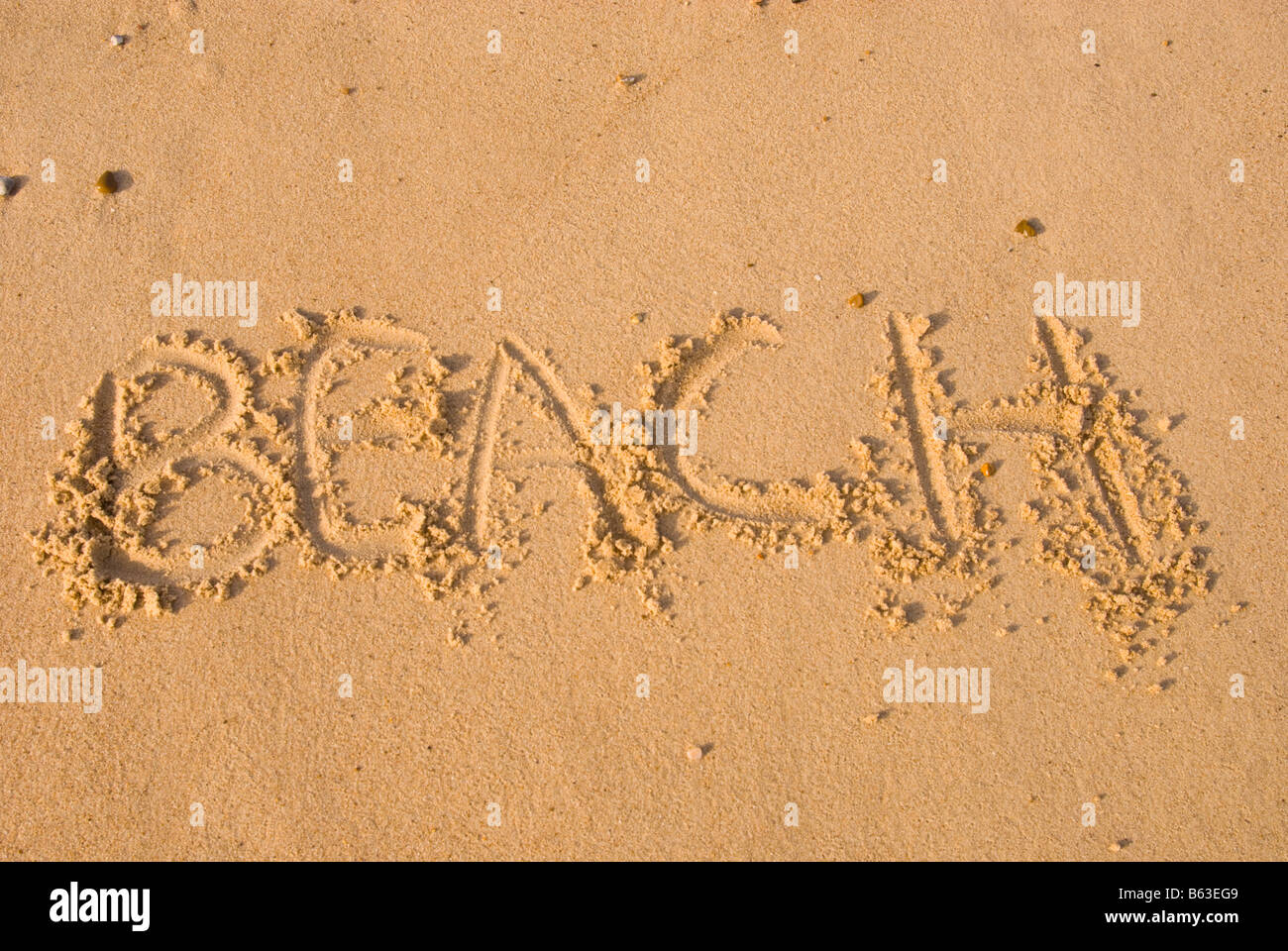 Beach written in sand on beach Stock Photo - Alamy