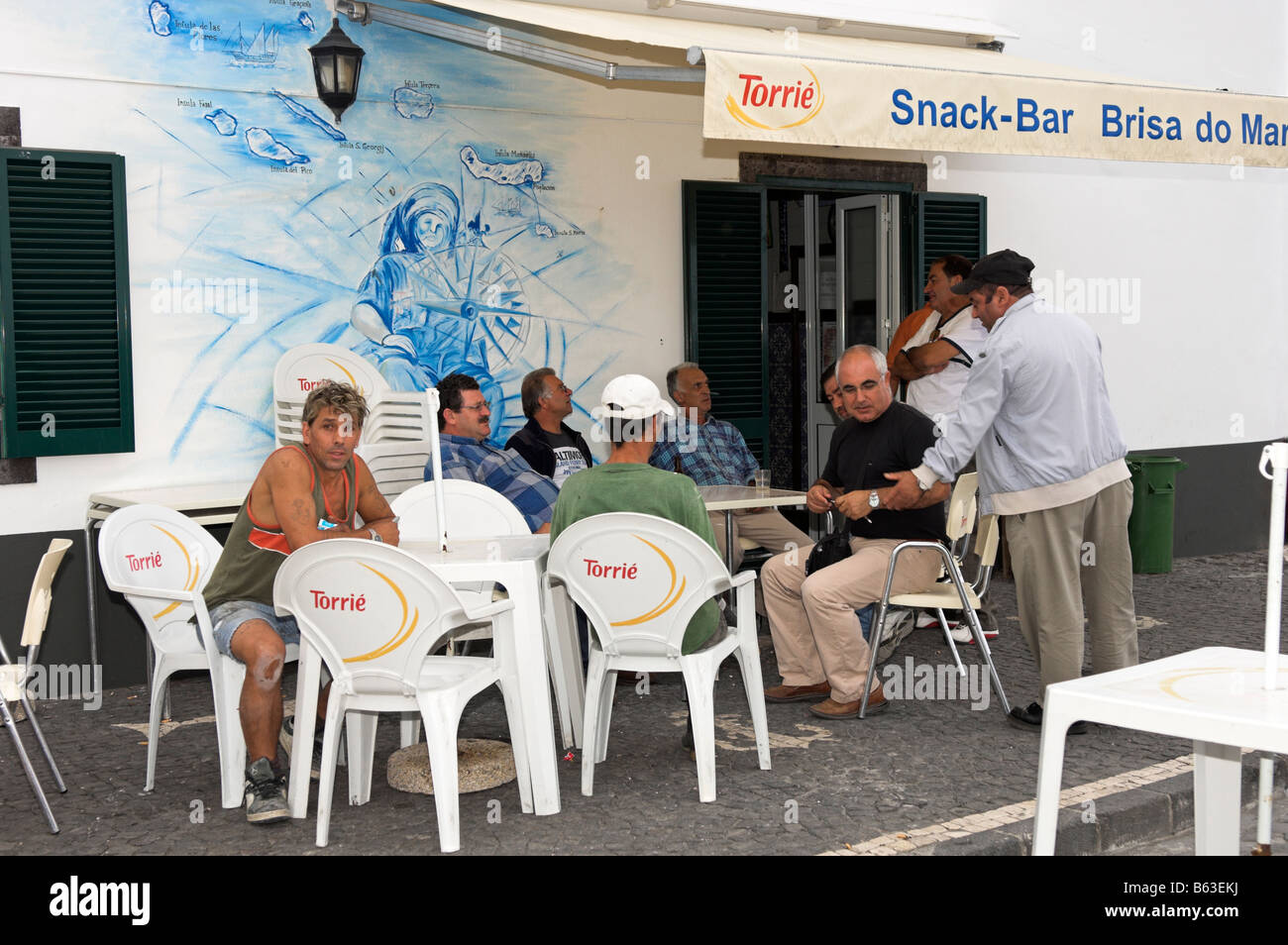 Local men sitting outside at bar in small village Stock Photo - Alamy