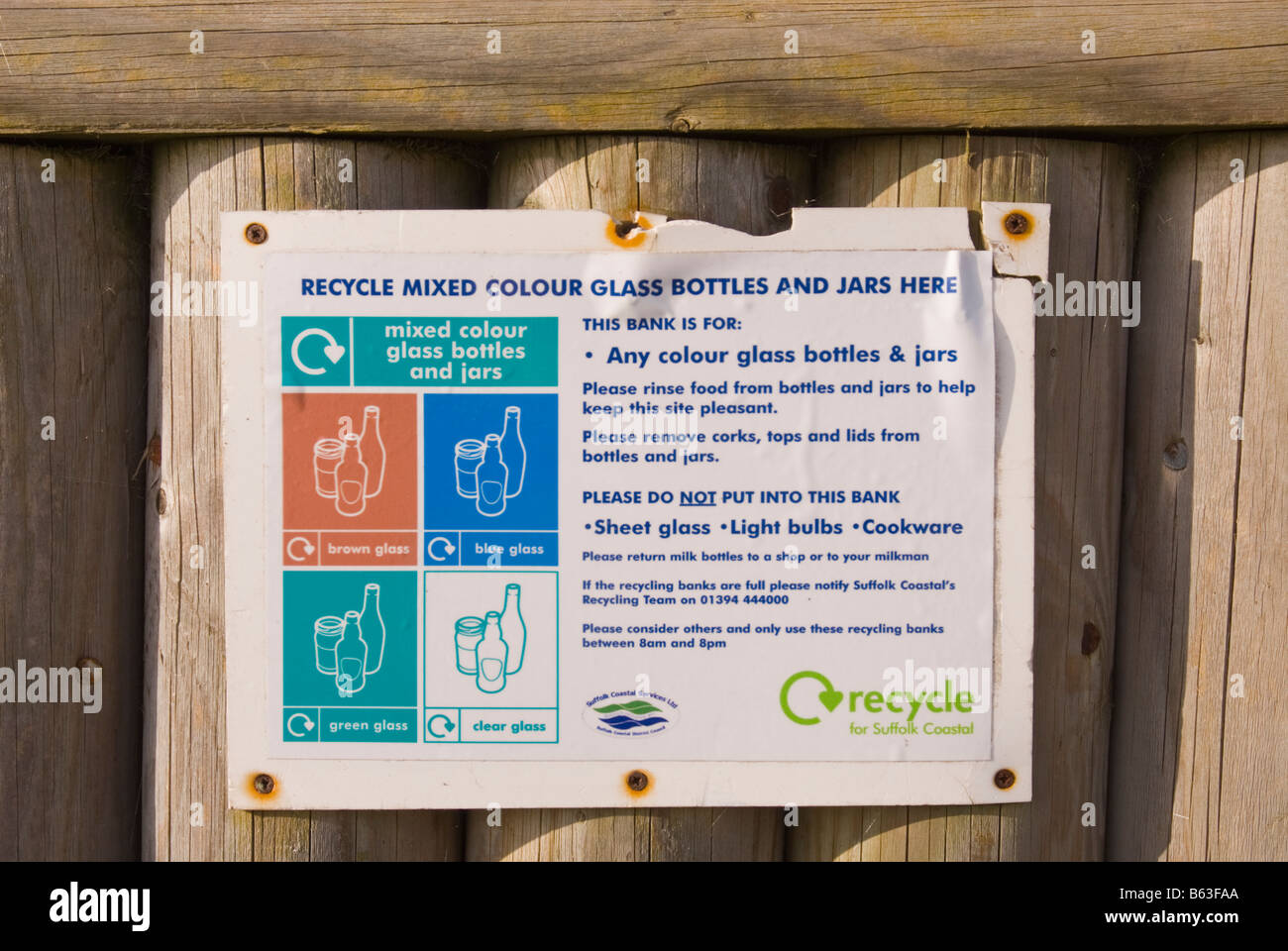 Sign at mixed coloured glass recycling bank in the uk Stock Photo - Alamy