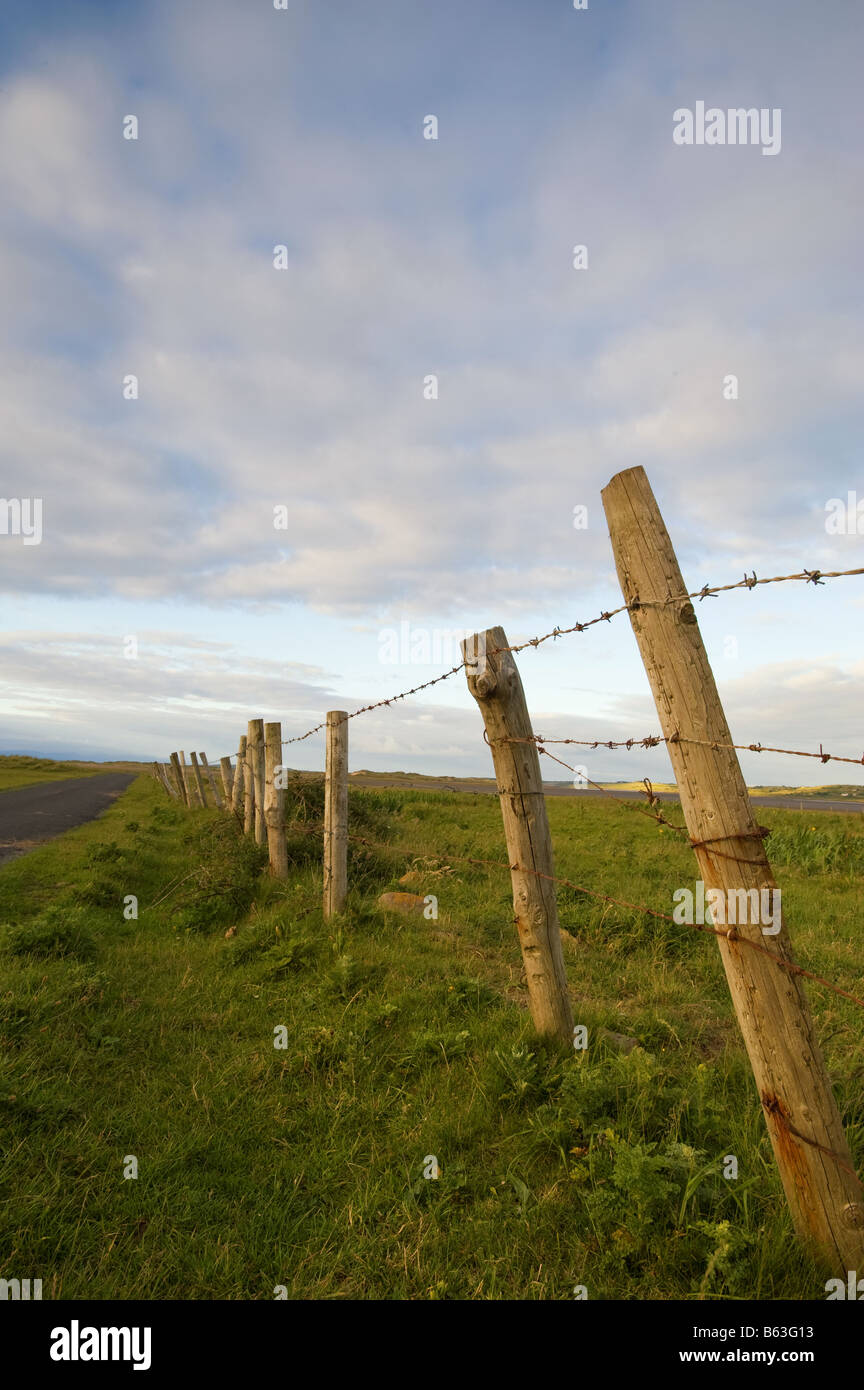 rural scene from Co.Sligo, Ireland shows stone wall topped with barbed ...
