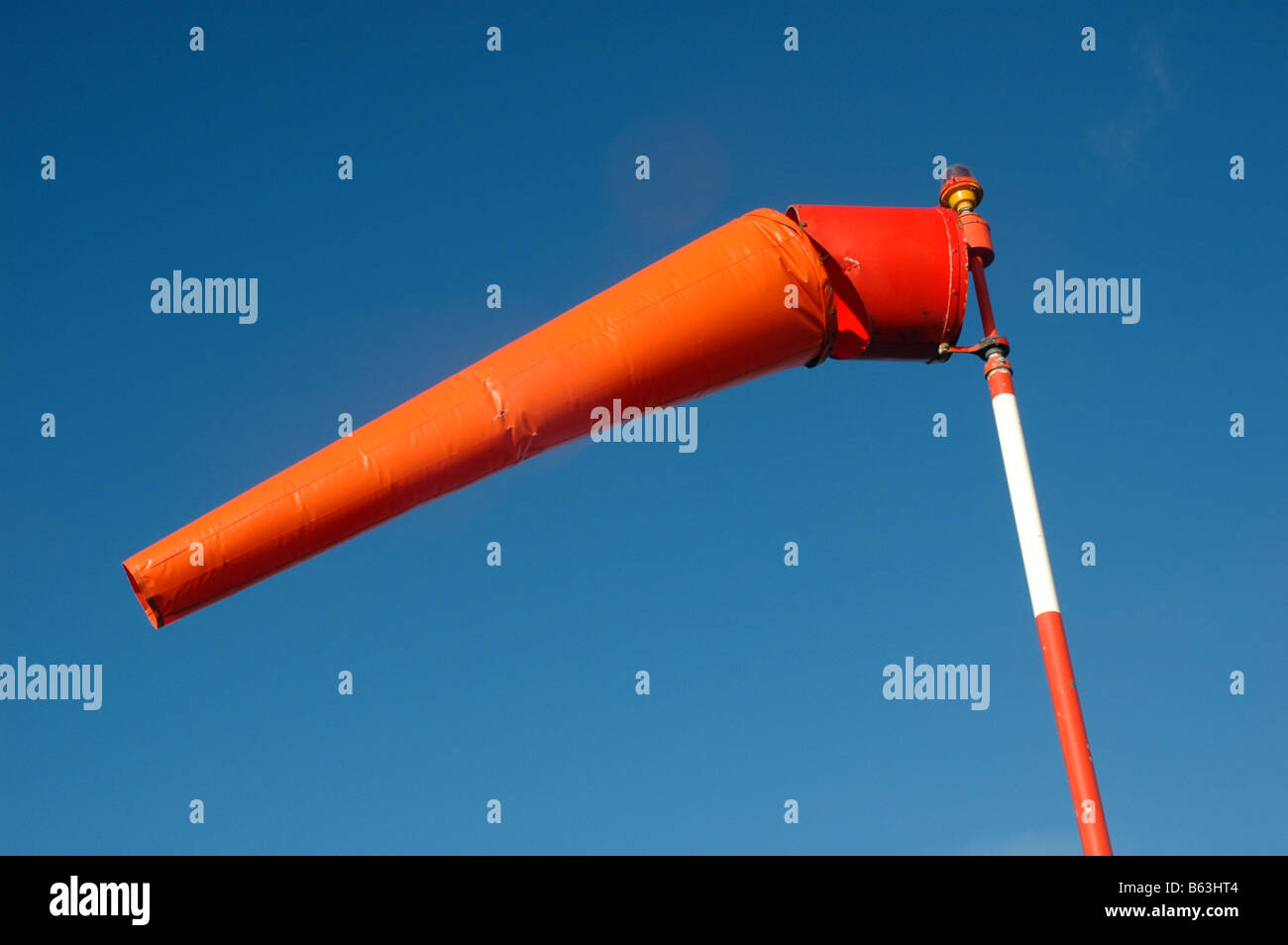 Airport Windsock blowing in the breeze with a blue sky background Stock ...