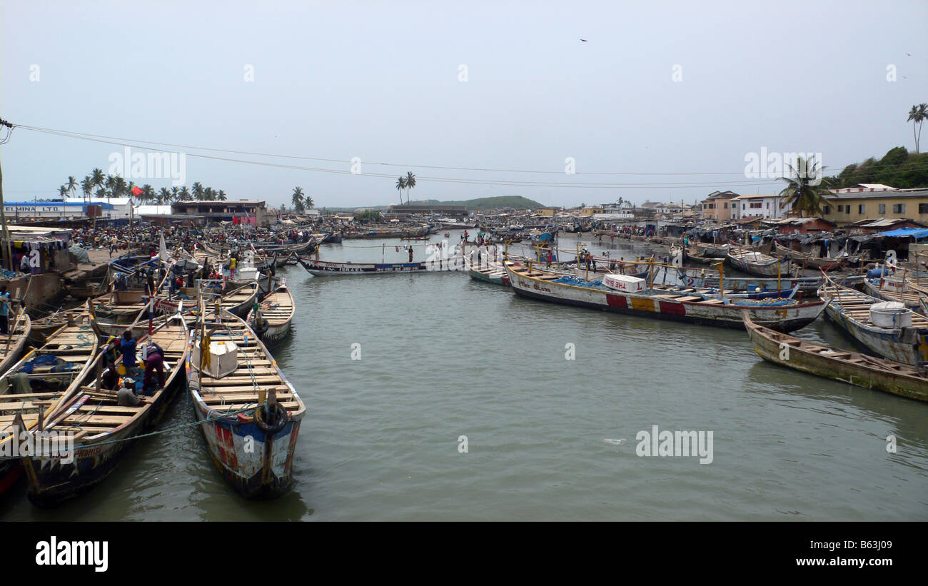 Traditional fishing come into the harbor at Elmina, Ghana after a day ...