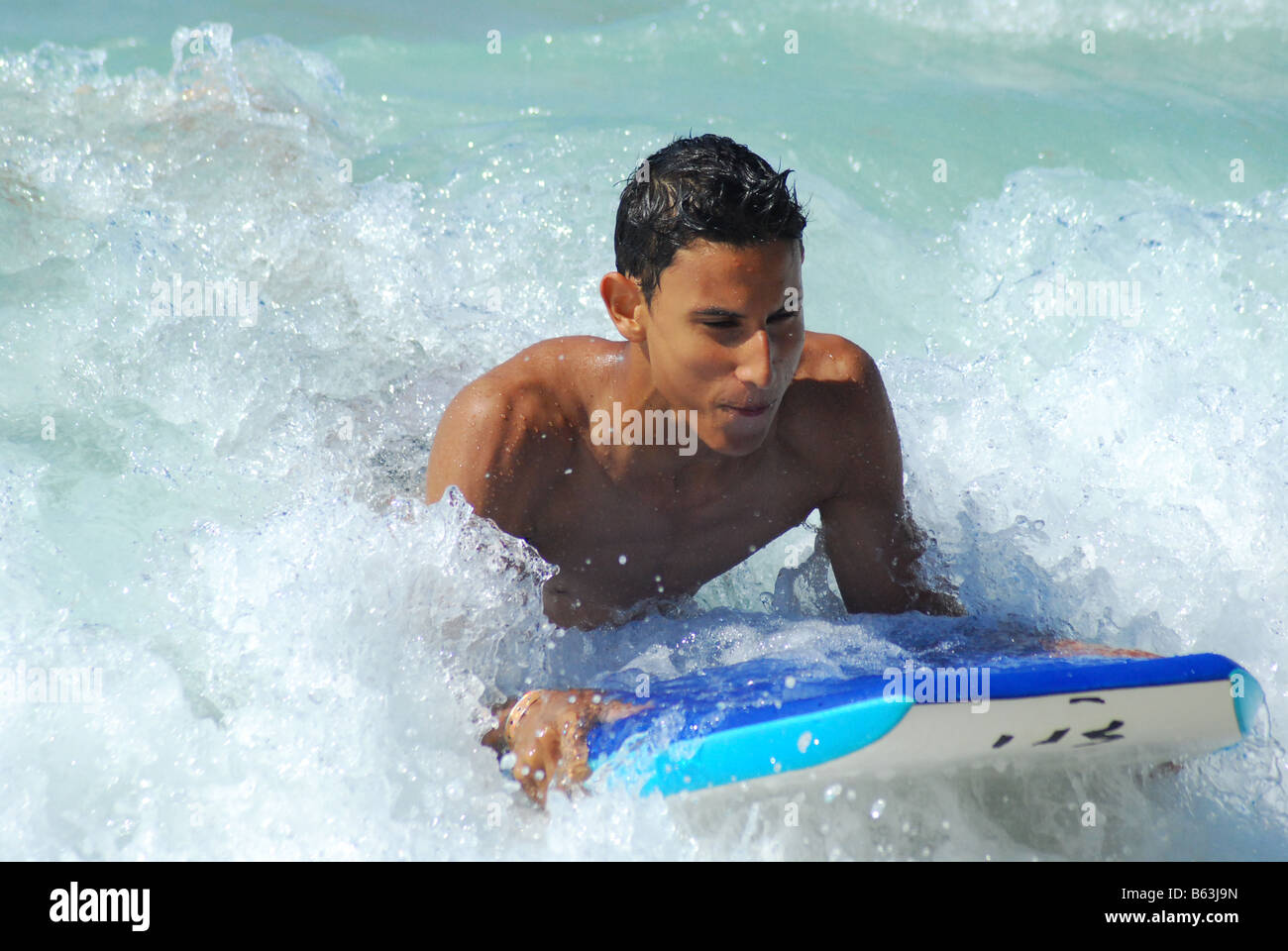 A boy doing bodyboarding in Punta Cana Beach, Dominican Republic Stock ...