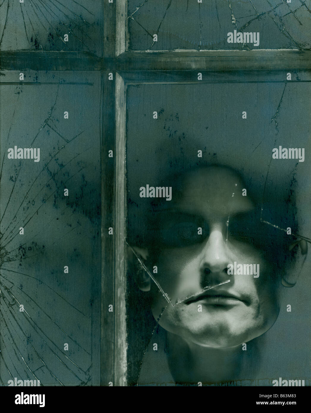 a monochrome black and white photograph featuring a man looking out ...