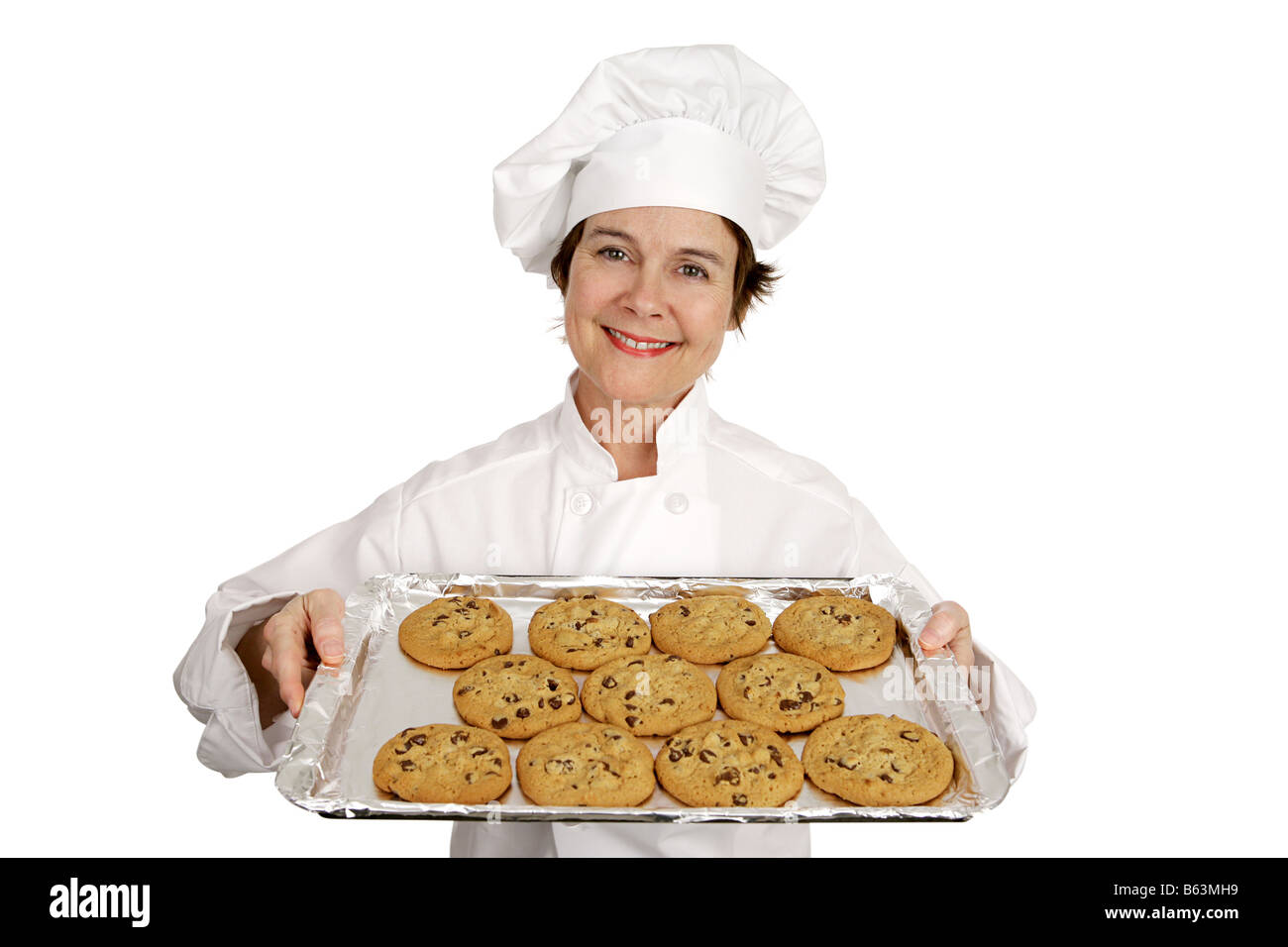 Pretty female chef holding a tray of freshly baked chocolate chip ...